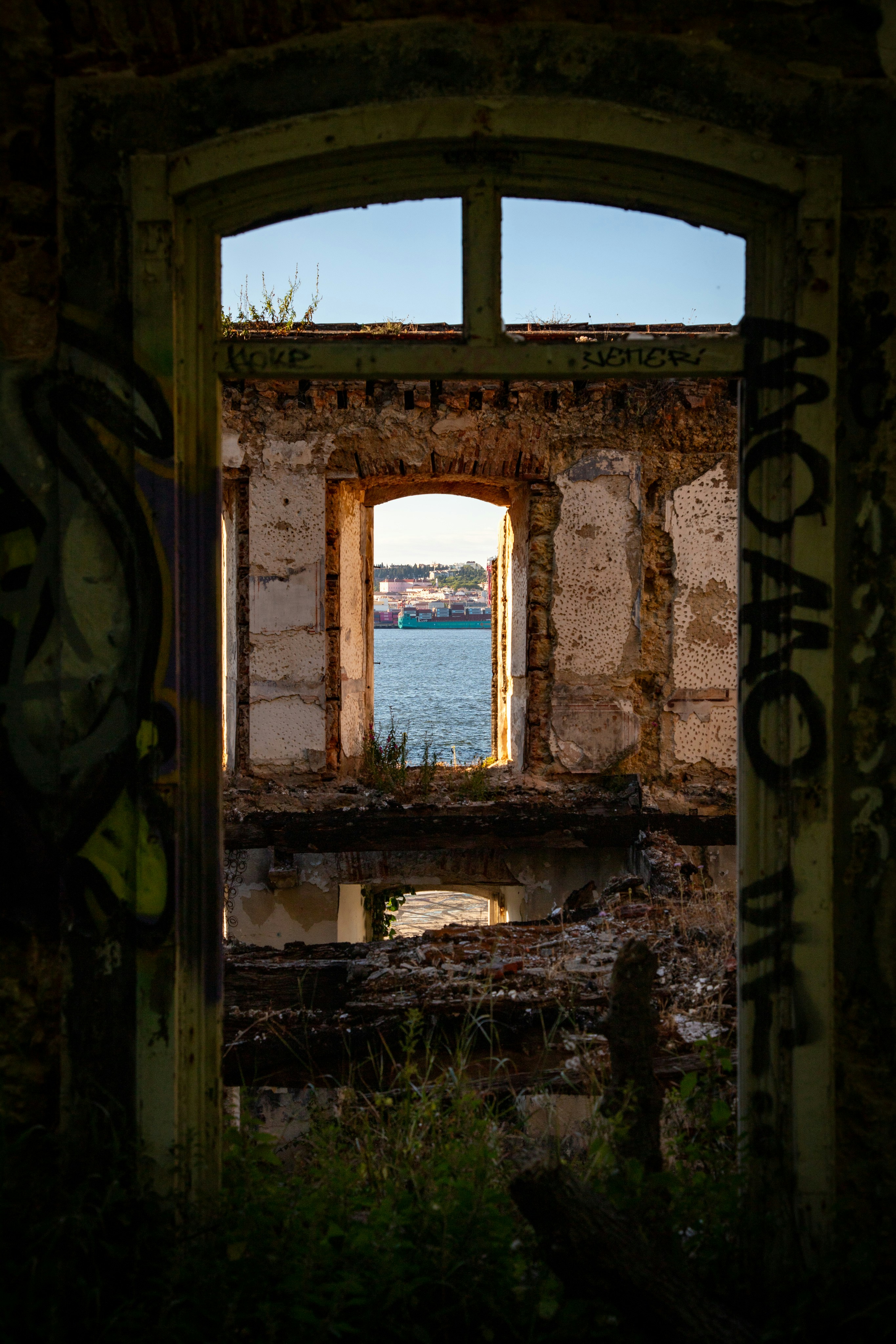 Through the Ruins: Framed Window to the Harbor Beyond