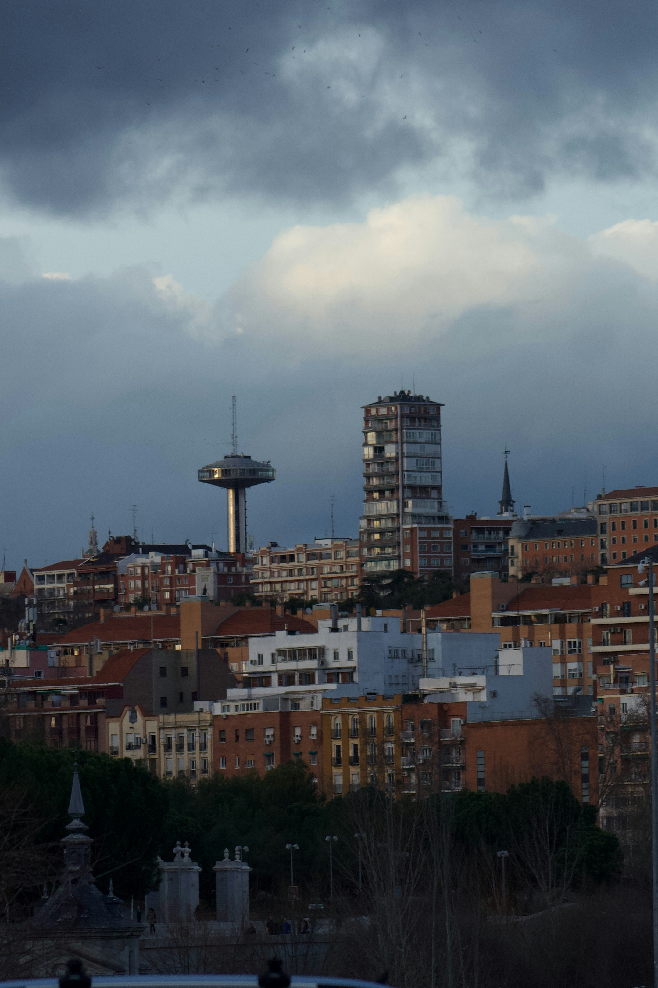 City Horizon: A towered skyline under drifting stormlight