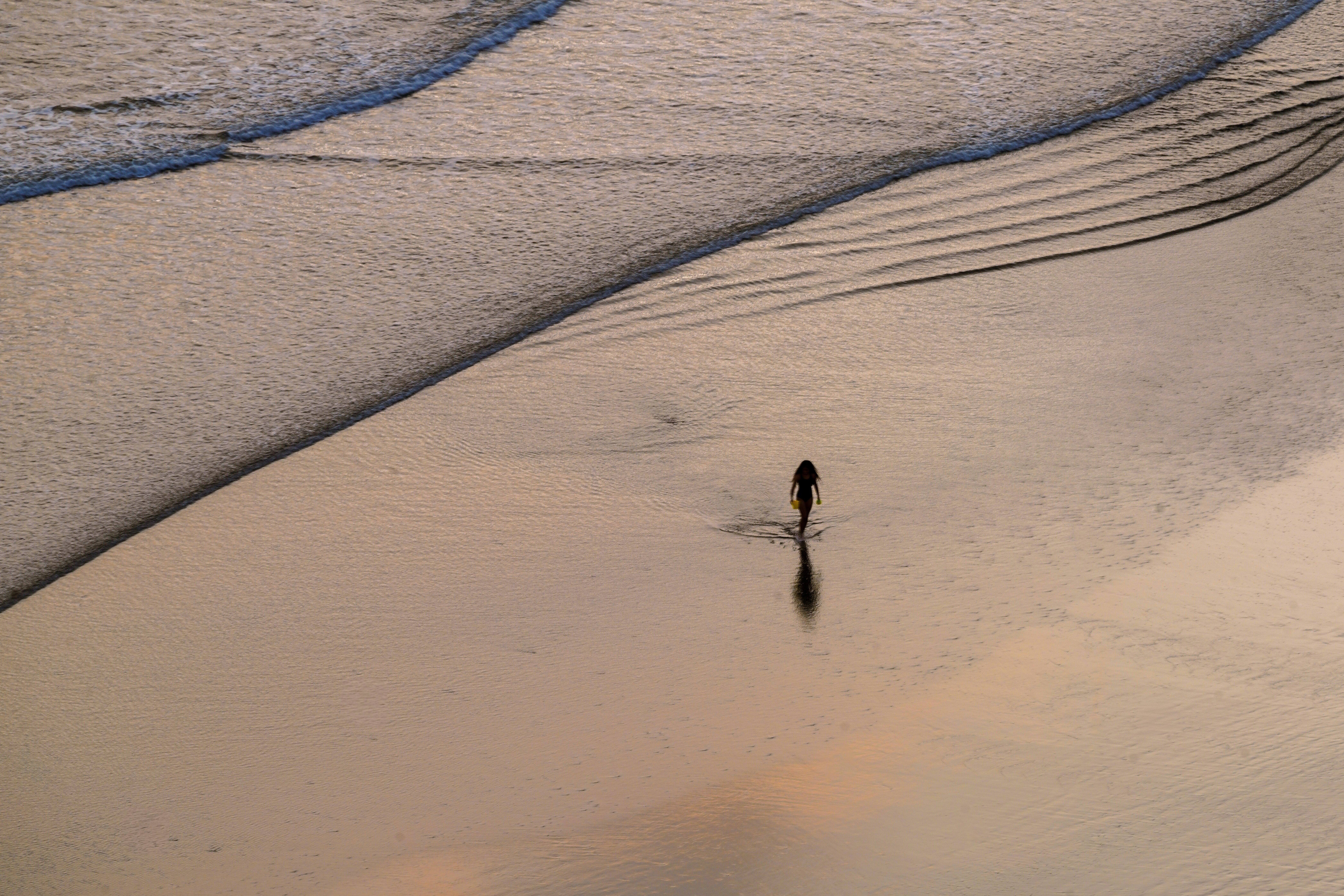 Footprints of Silence: One Traveller Across Wet Sand at Dawn