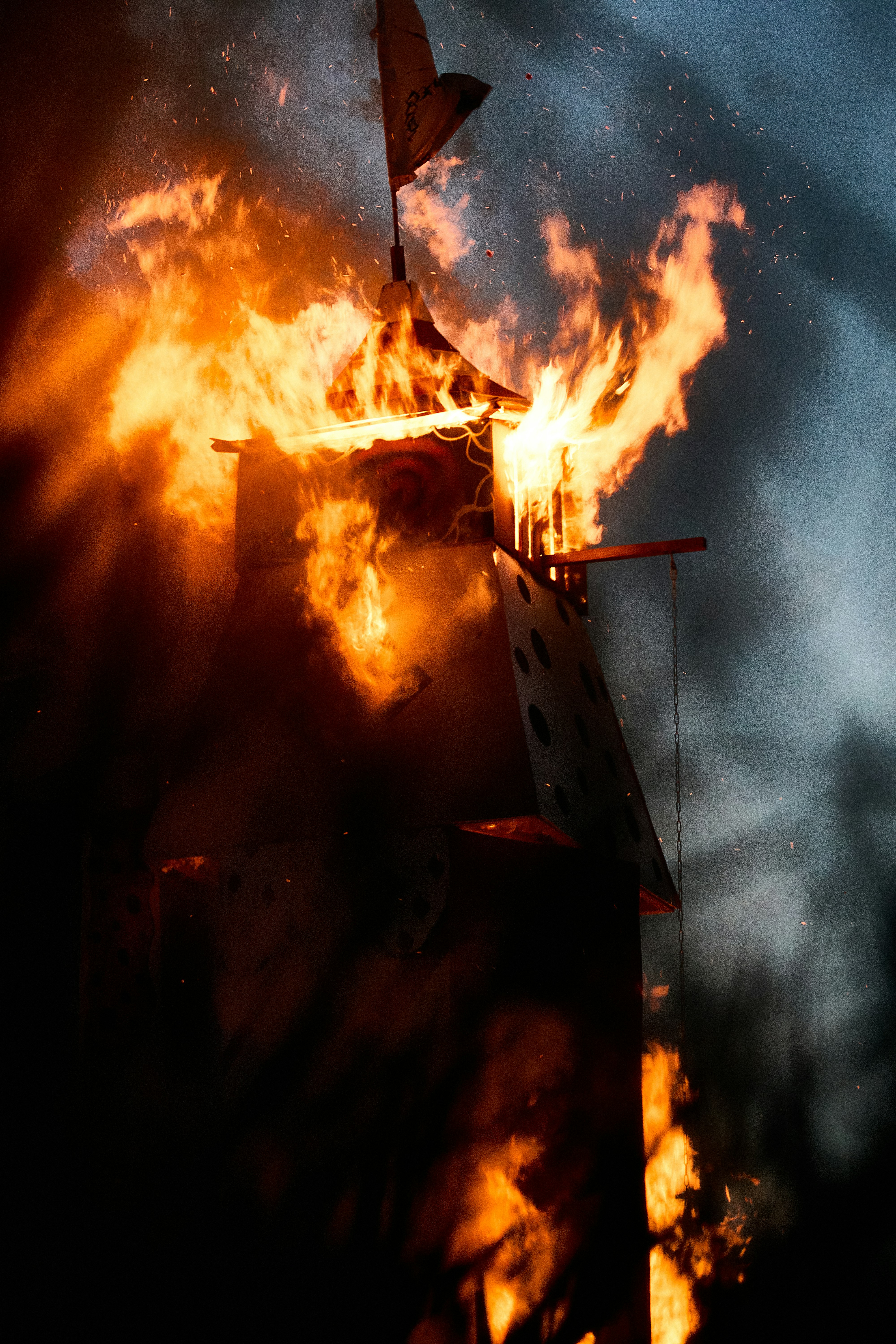 Inferno Tower: A Flame-Kissed Structure Rising from Dark Clouds