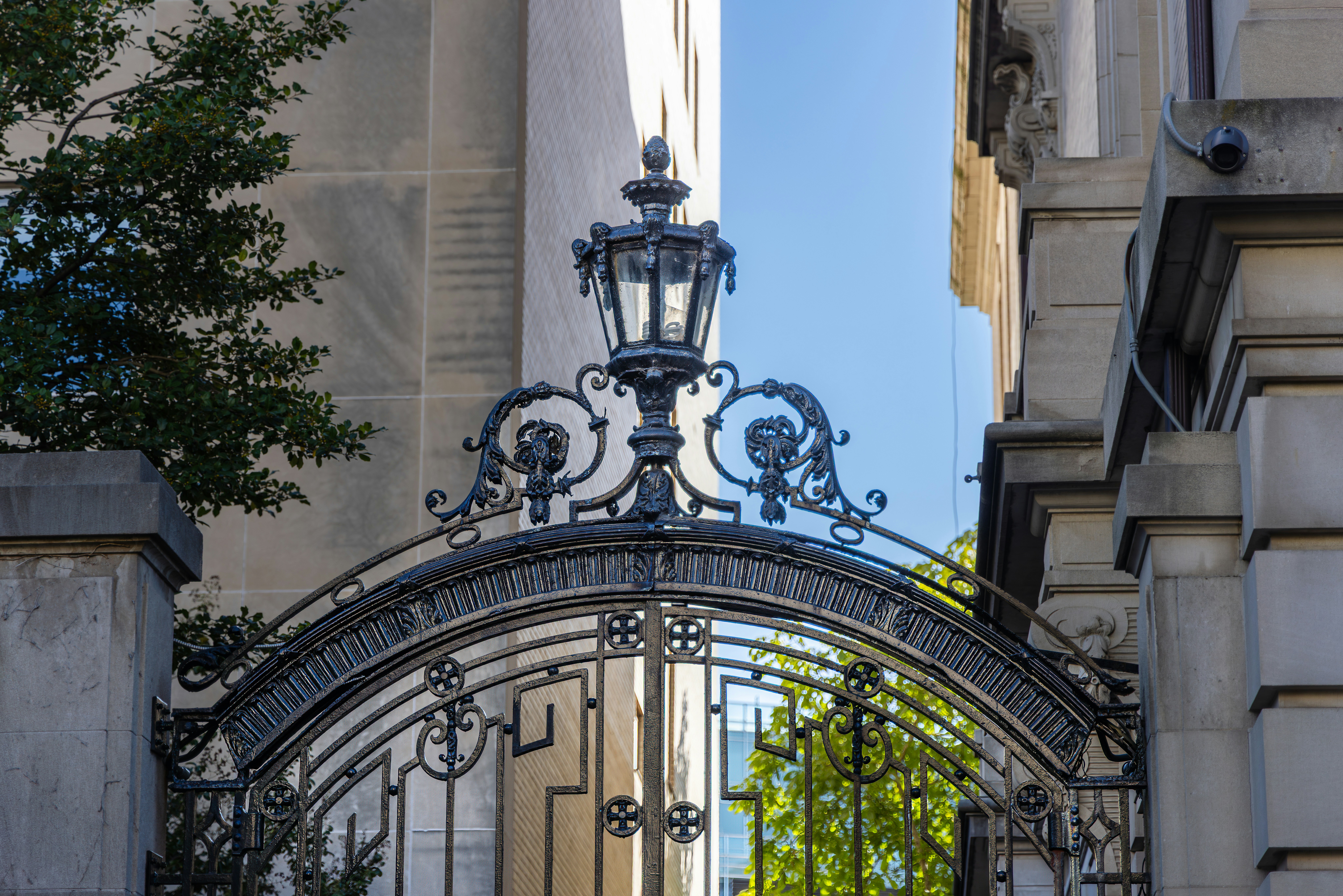 Ornate Gatehouse Lantern Framed by Stone Facades