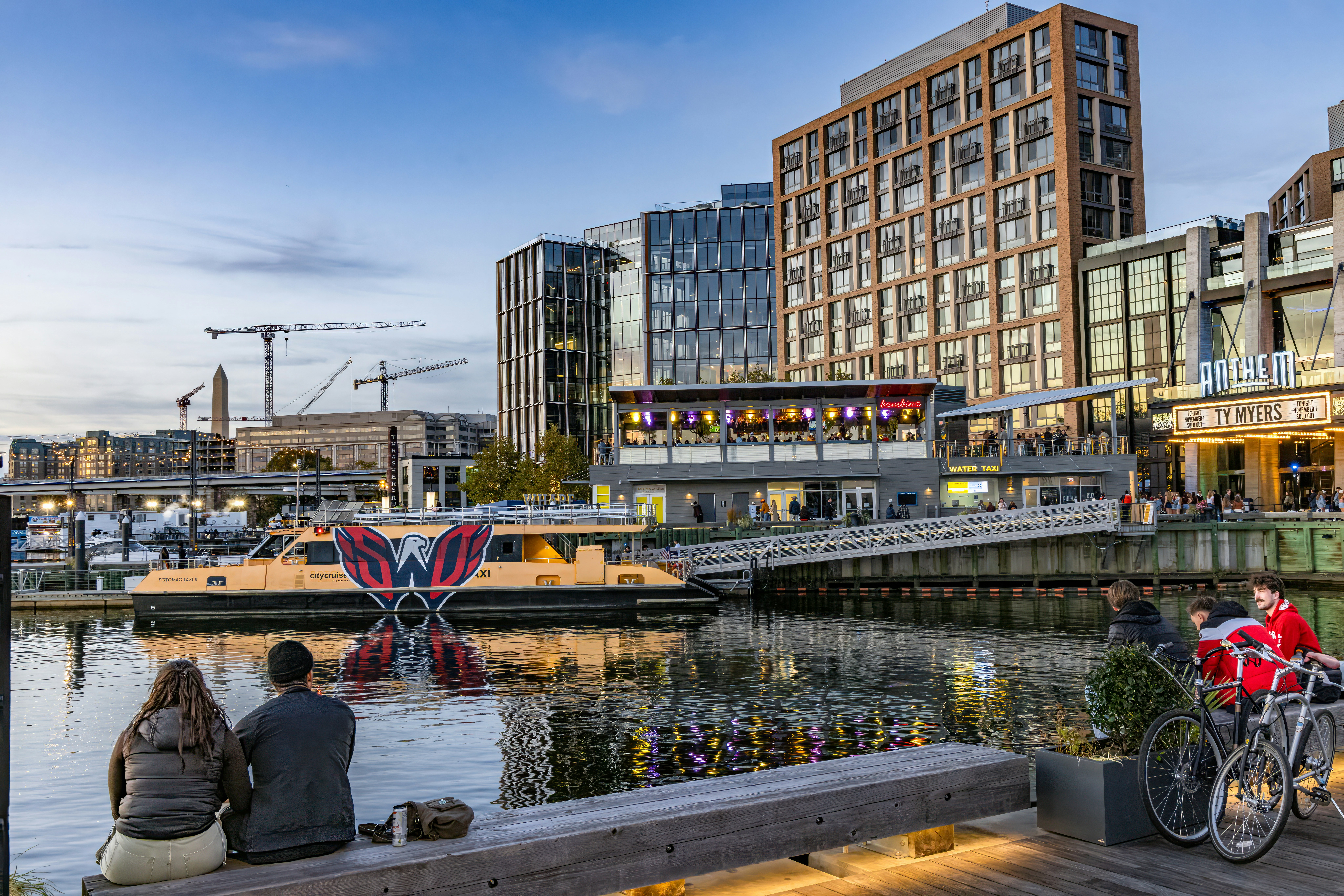 Urban Marina at Dusk: Boats, Bar, and Bright Reflections