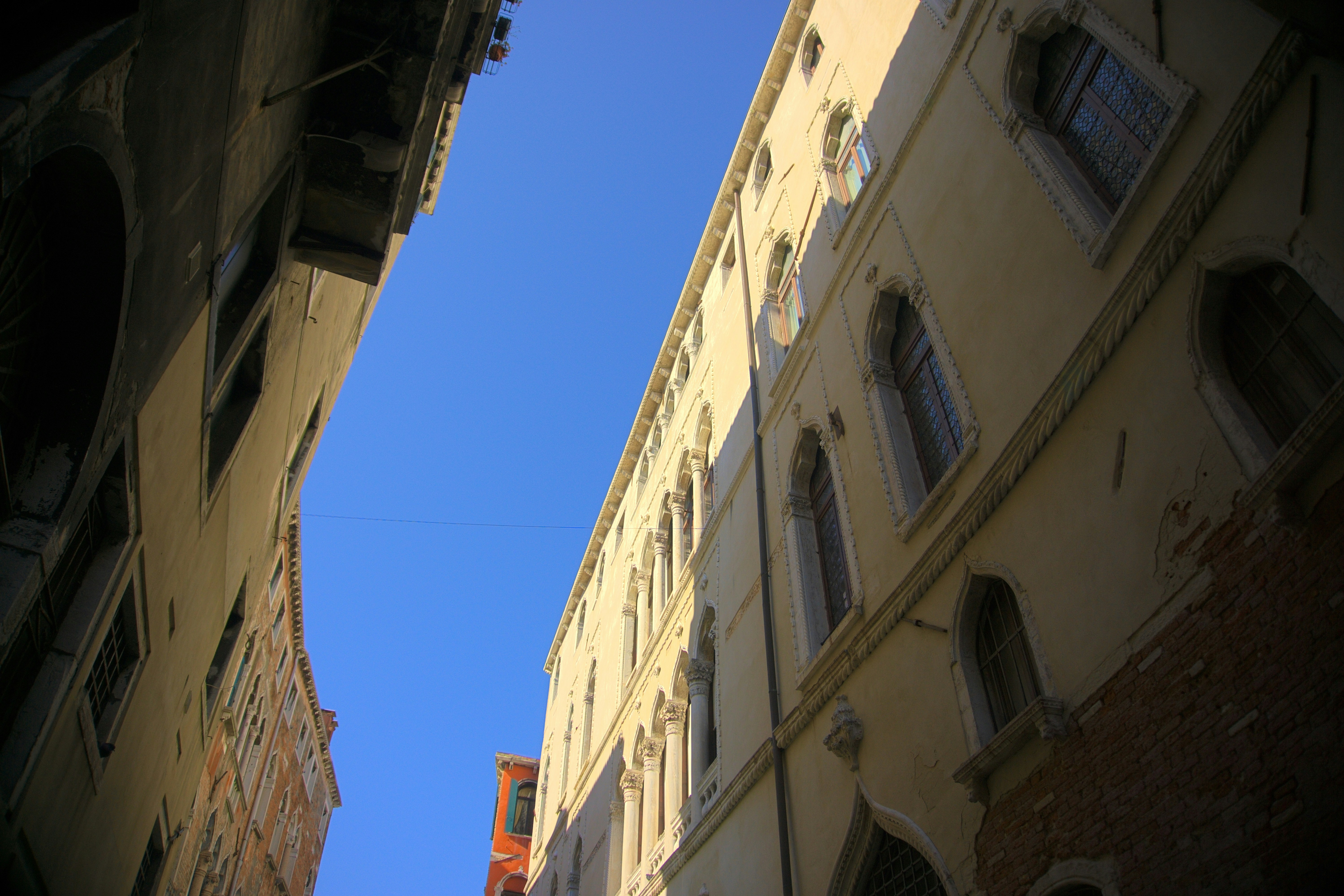 Canted Facades: Sky Between Narrow Alleys