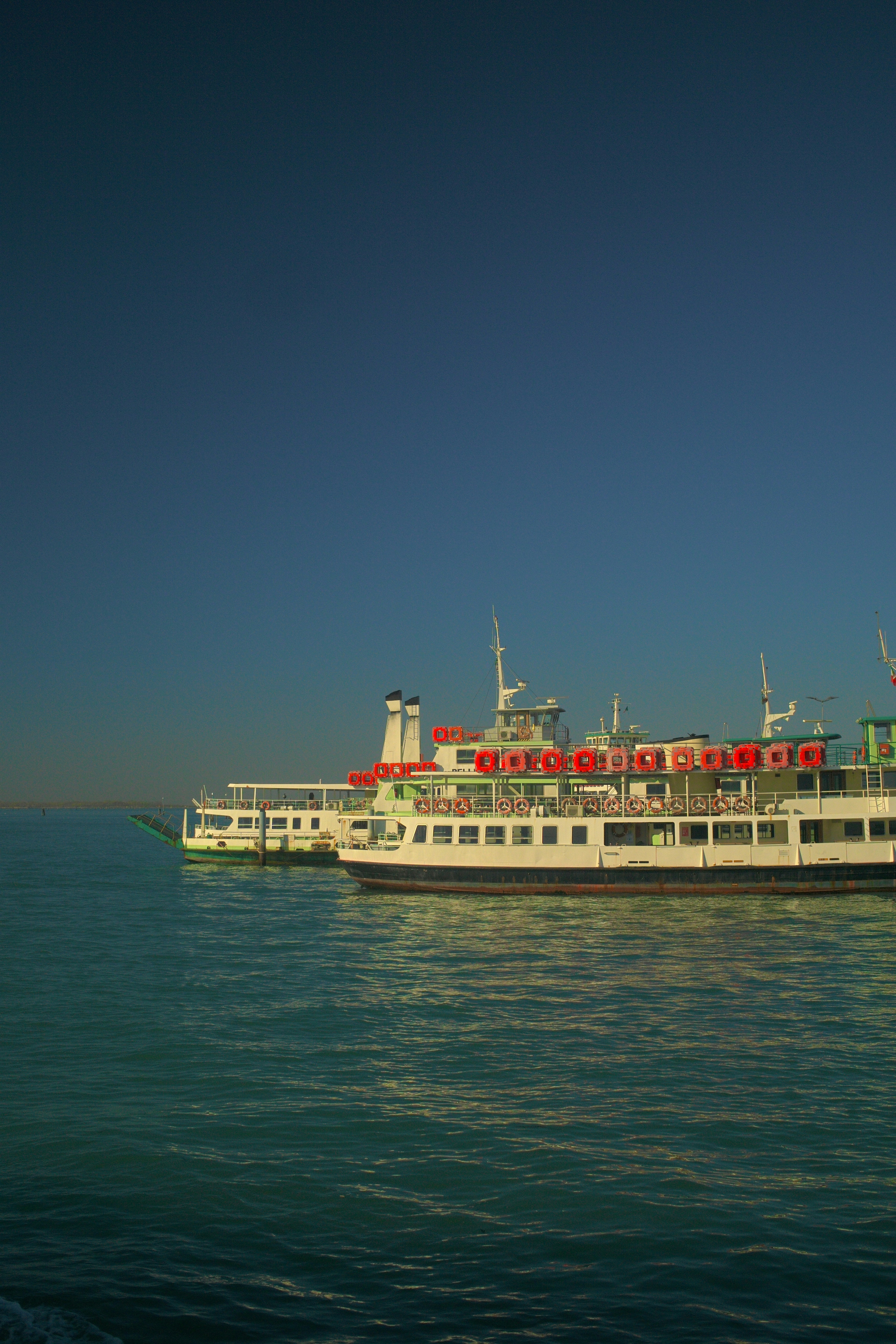Harbor Vessel at Dusk: A Quiet Lineup Along the Calm Sea