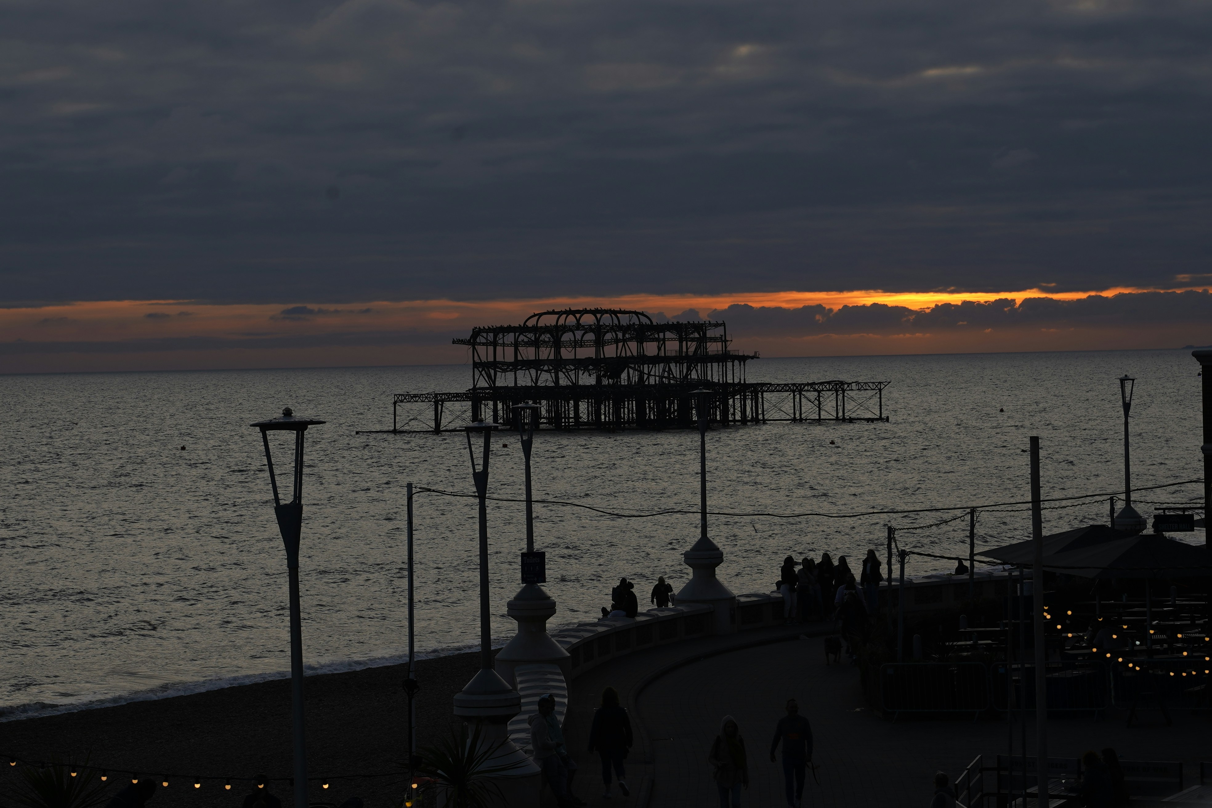 Silhouetted Pier at Dusk: Remnants of a Forgotten Pavilion