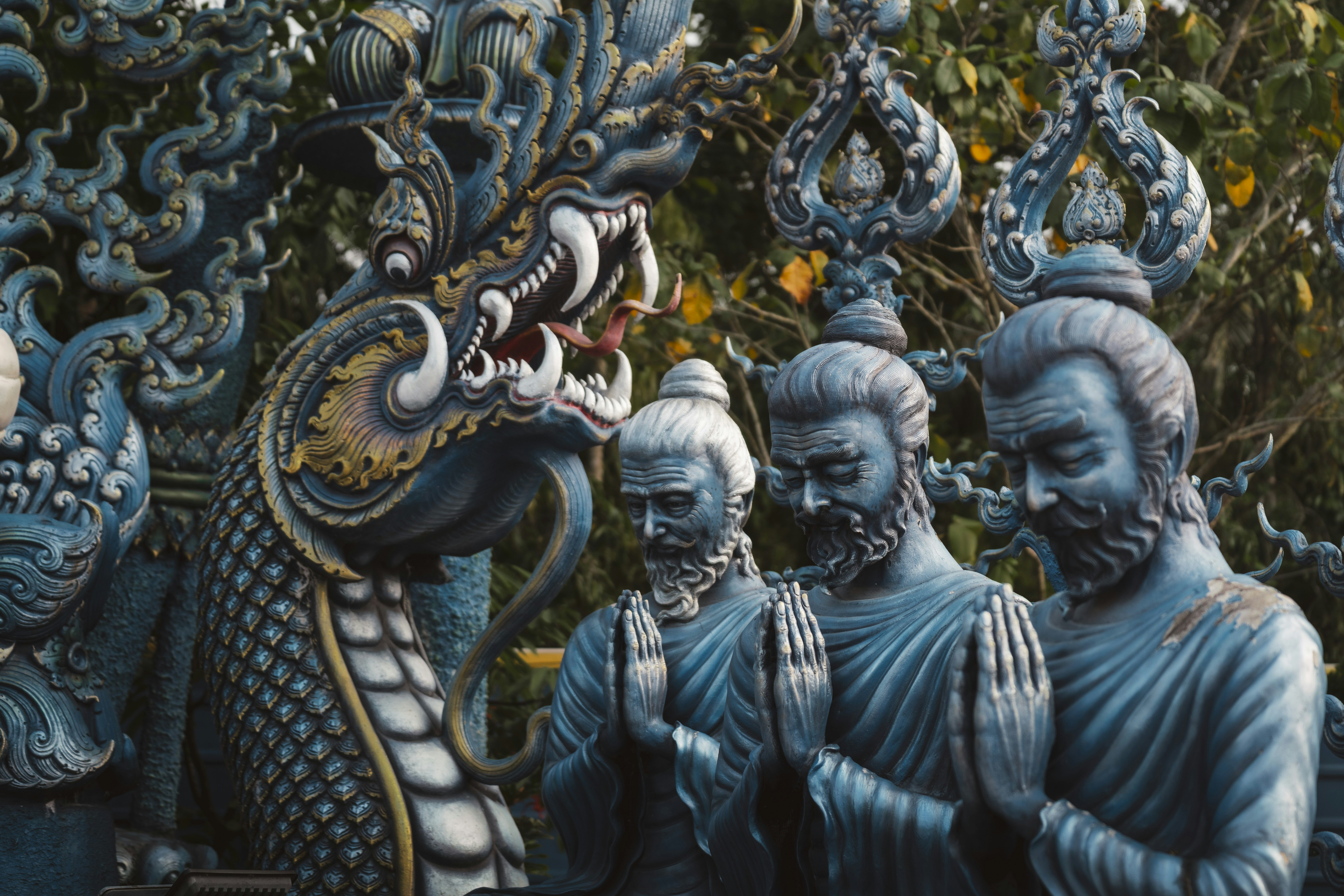 Guardians in Stone: Vigil of Serene Prayer amid Dragon Carvings