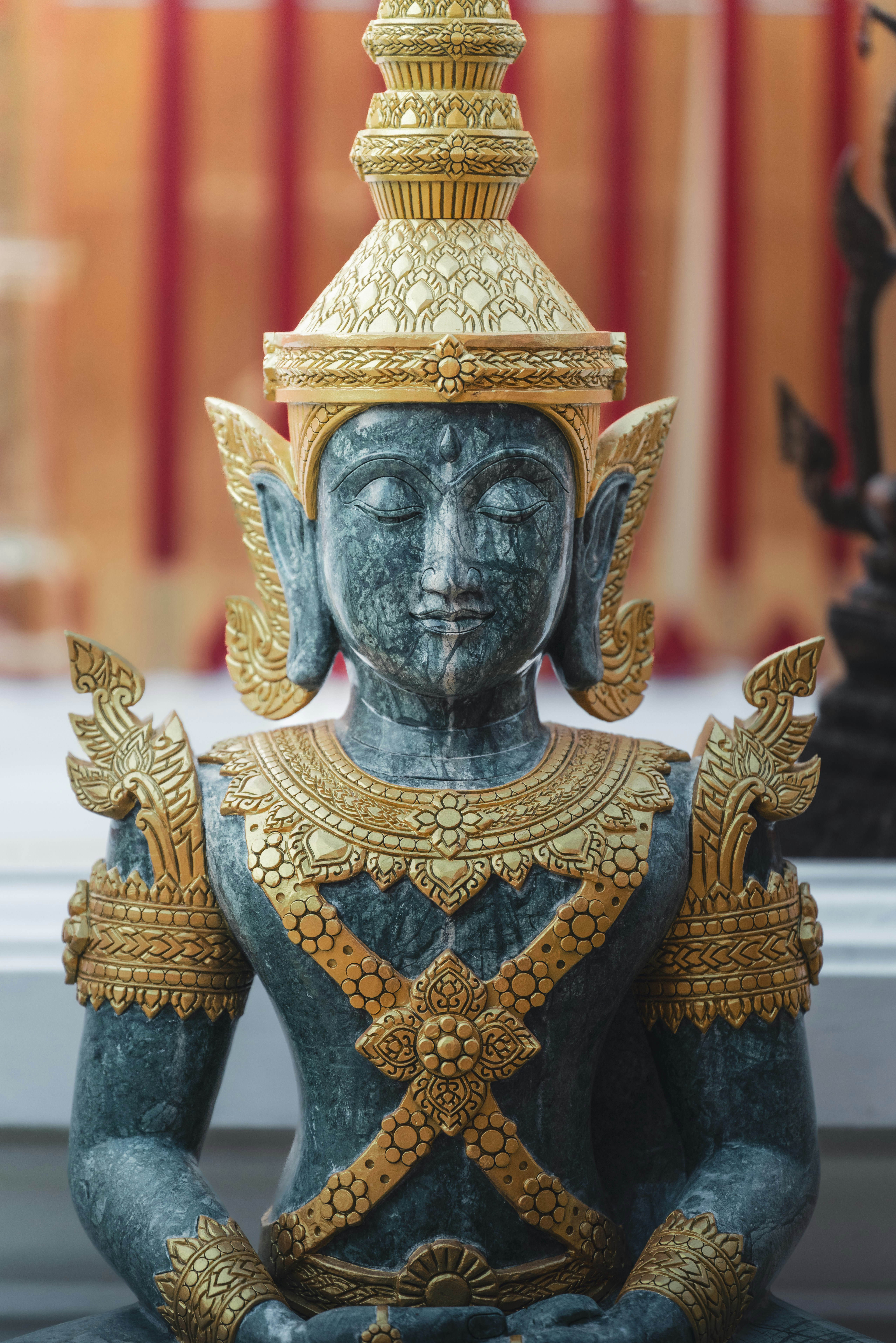 Golden Crown, Verdigris Saint: A Sacred Statue in Focus