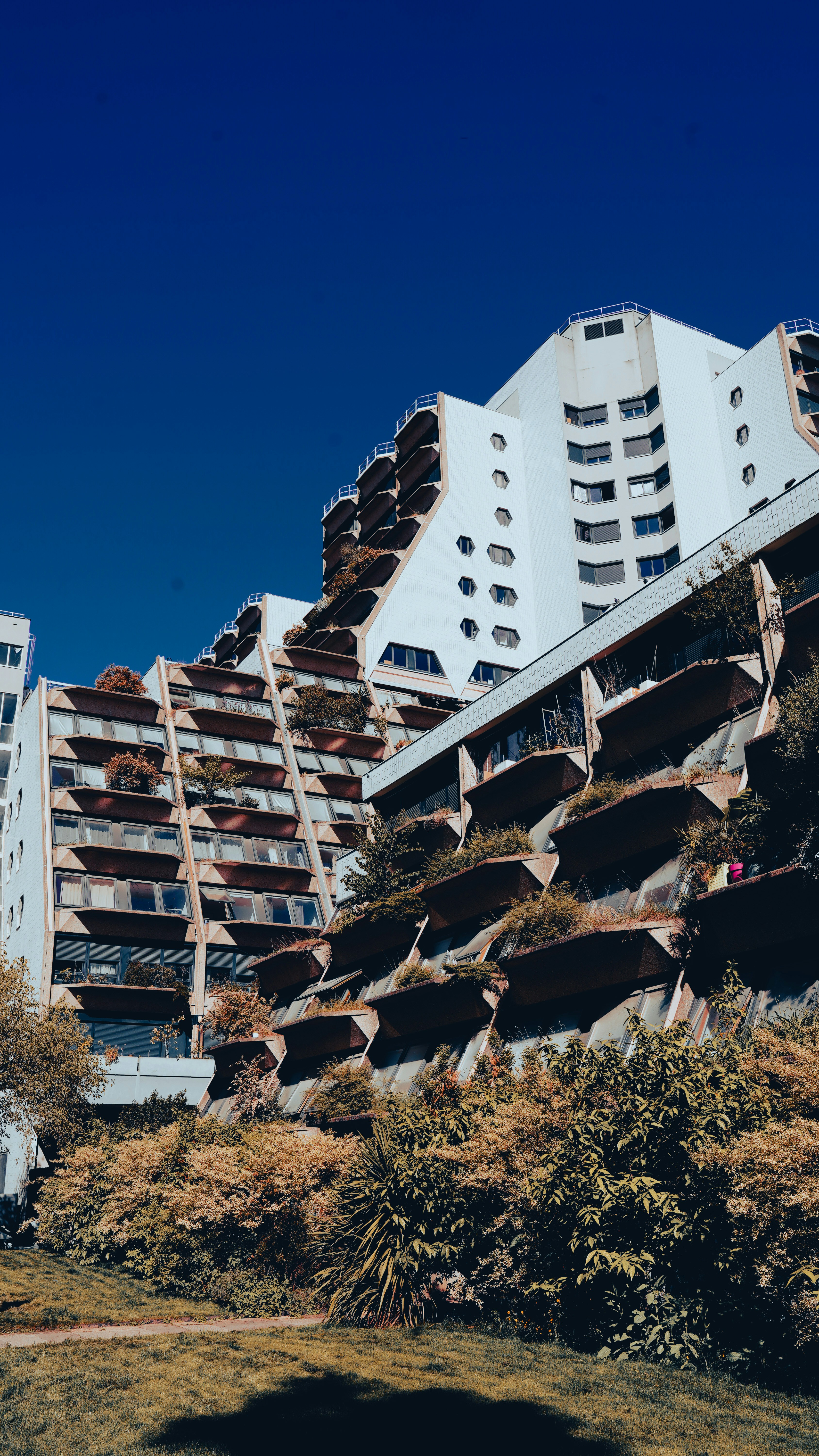 Concrete Facade Ascending: Terraced Architecture Against a Deep Sky
