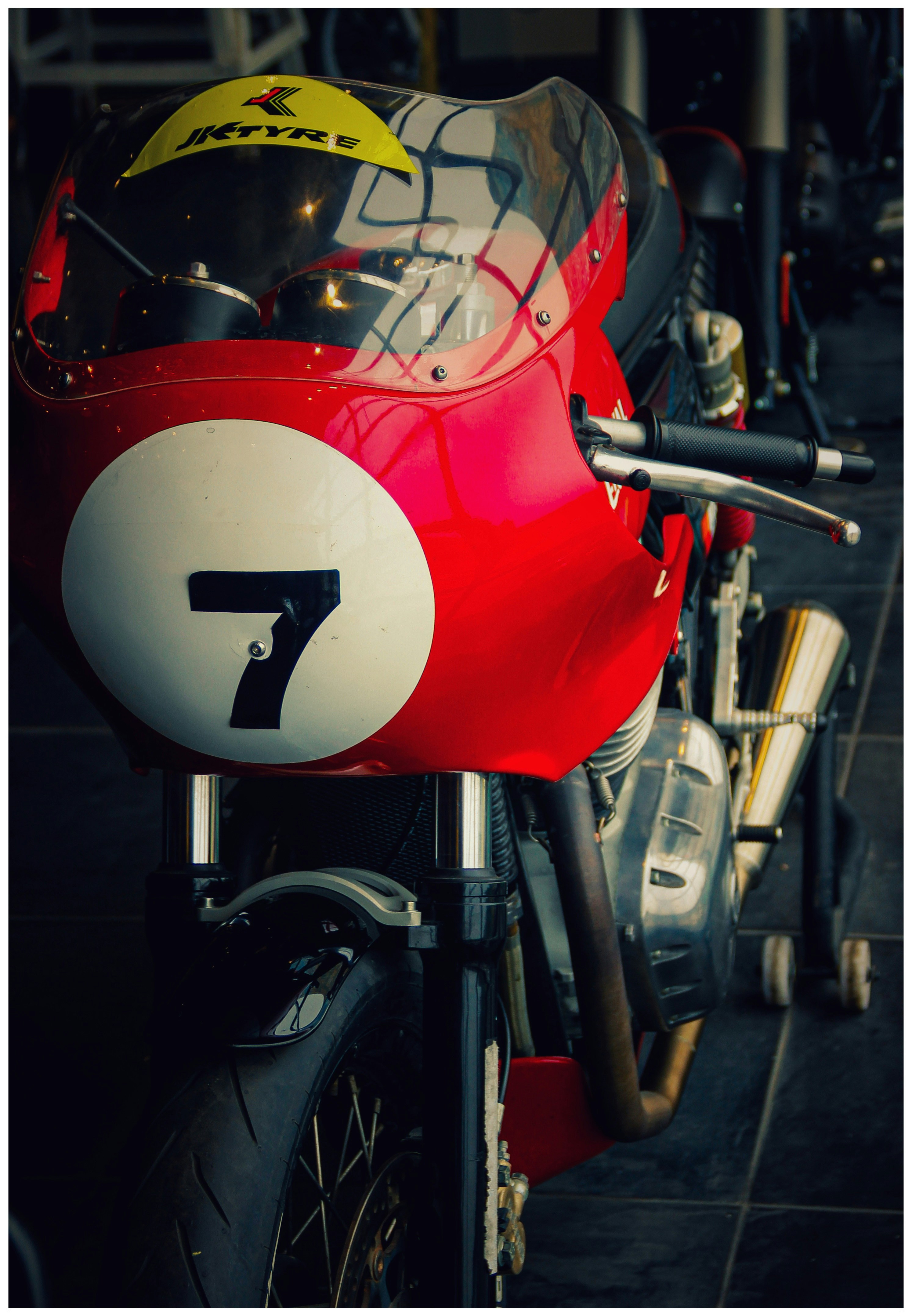 Number Seven in Red: A Race-Bike Portrait with Shiny Reflections