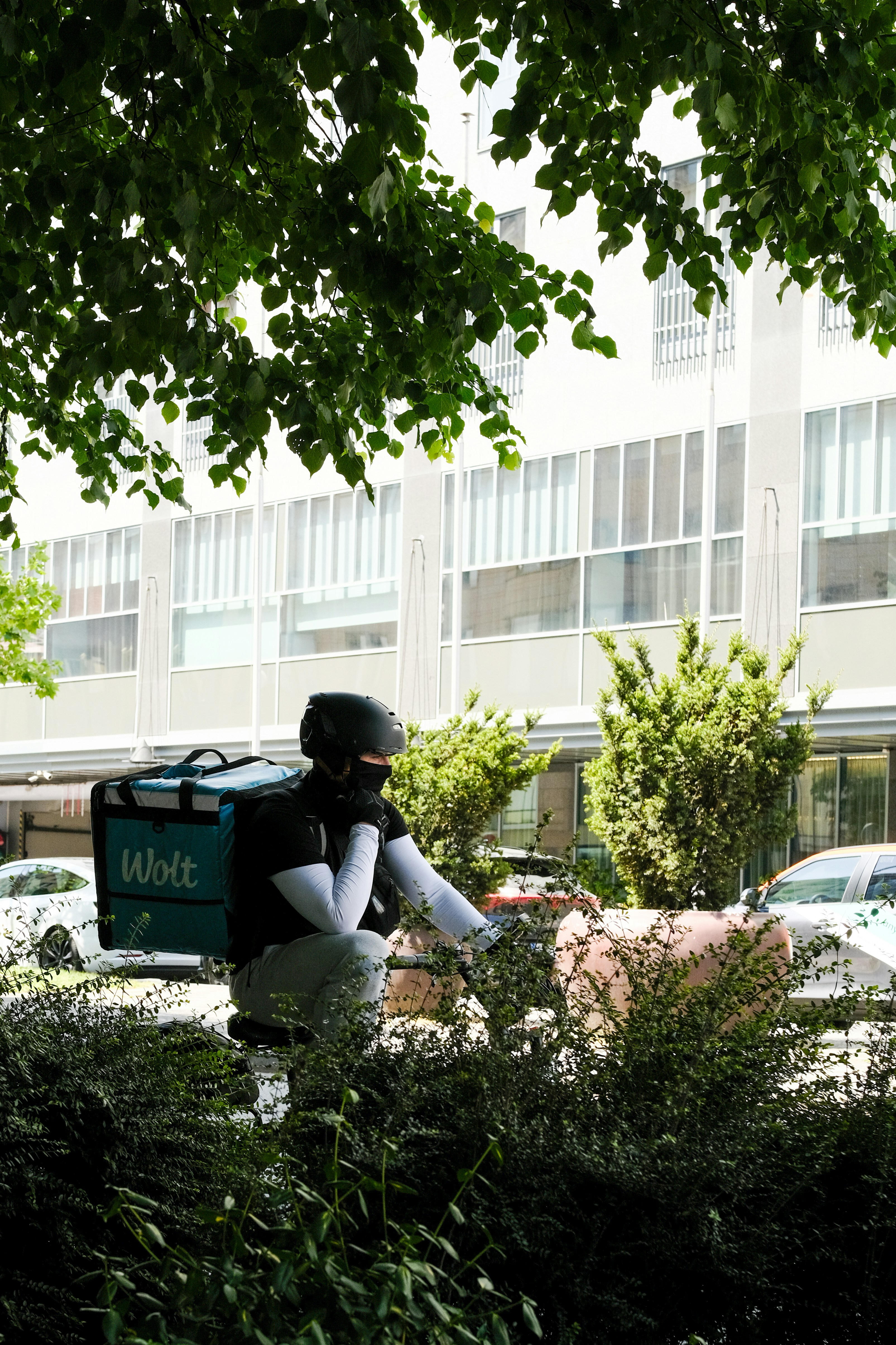 Delivery Rider in Urban Green Corridor