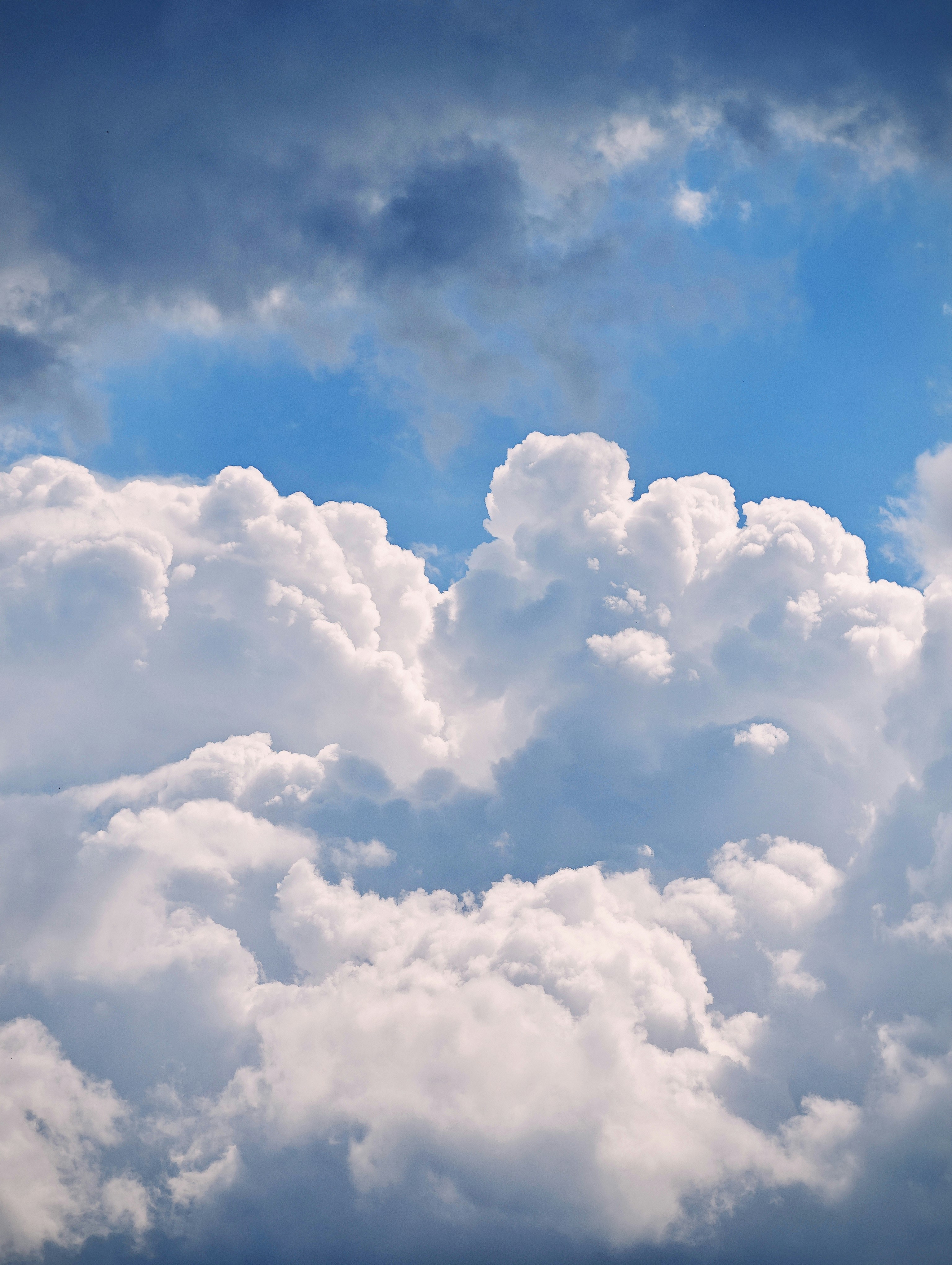 Sky Cathedral: Layered Clouds Piercing a Clear Blue