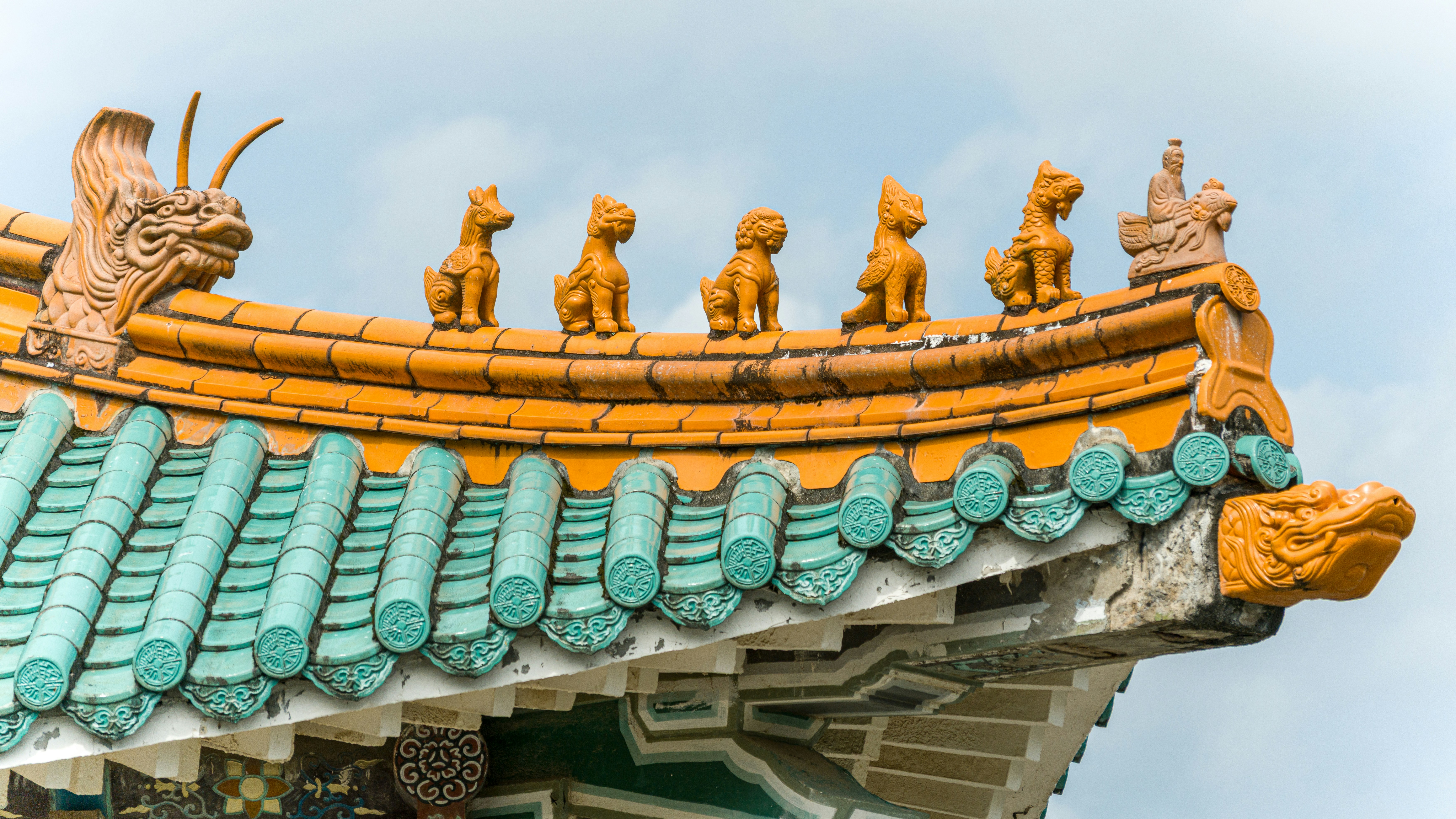 Terracotta Guardians Stand Sentinel Over a Turquoise Roof