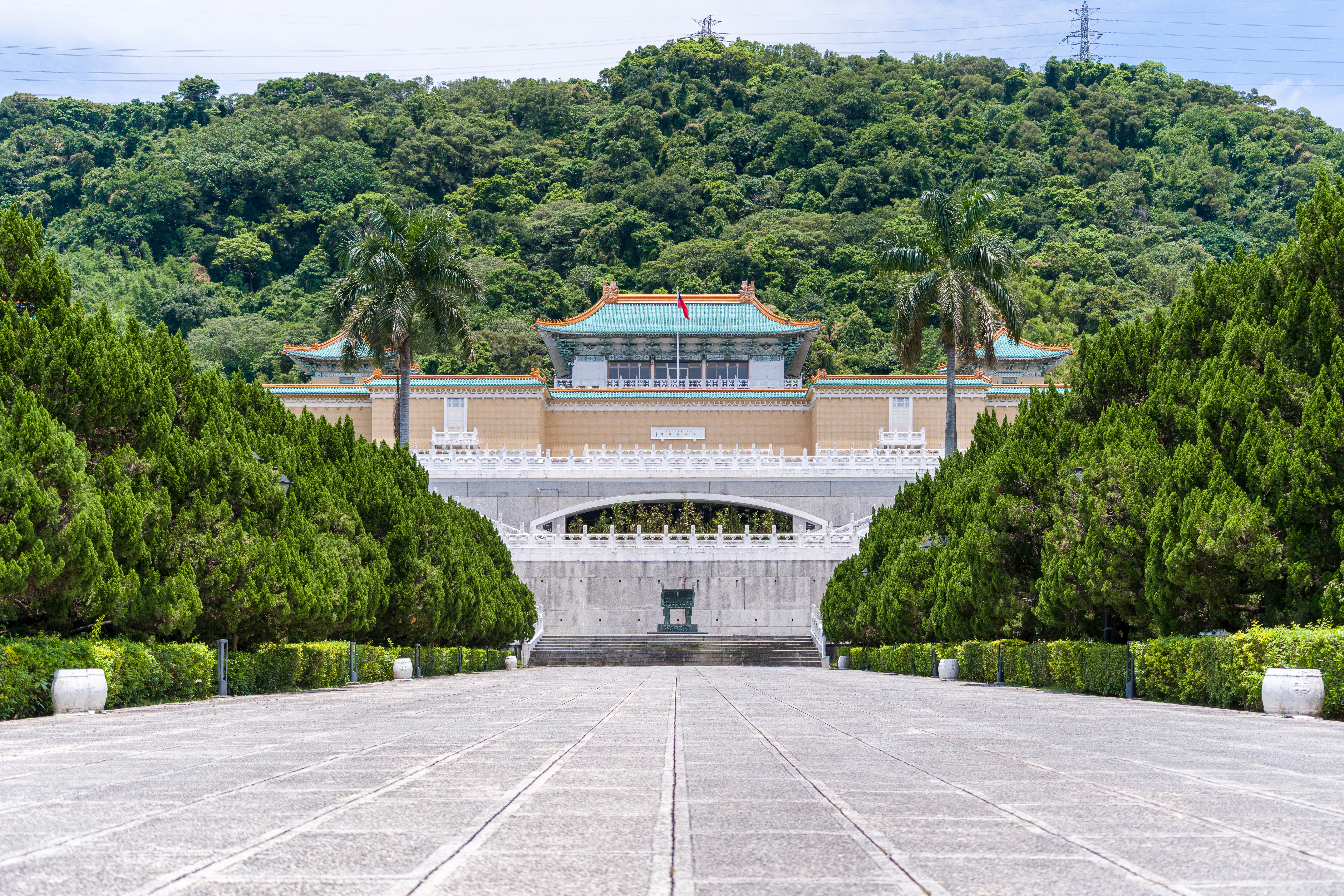 Temple Gate Framed by Colonnades and Green Hills