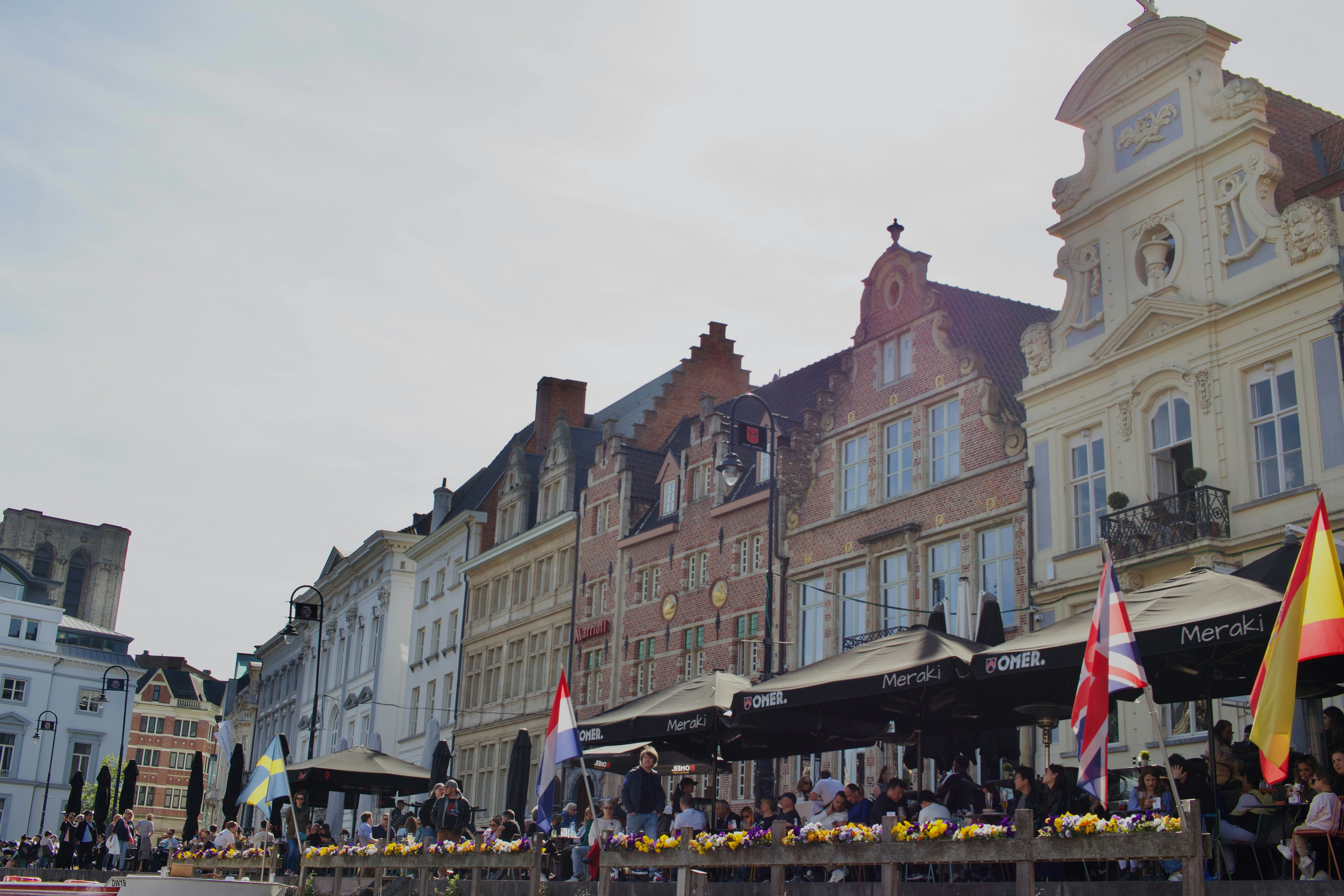 Row of historic waterfront shops lit by midday sun