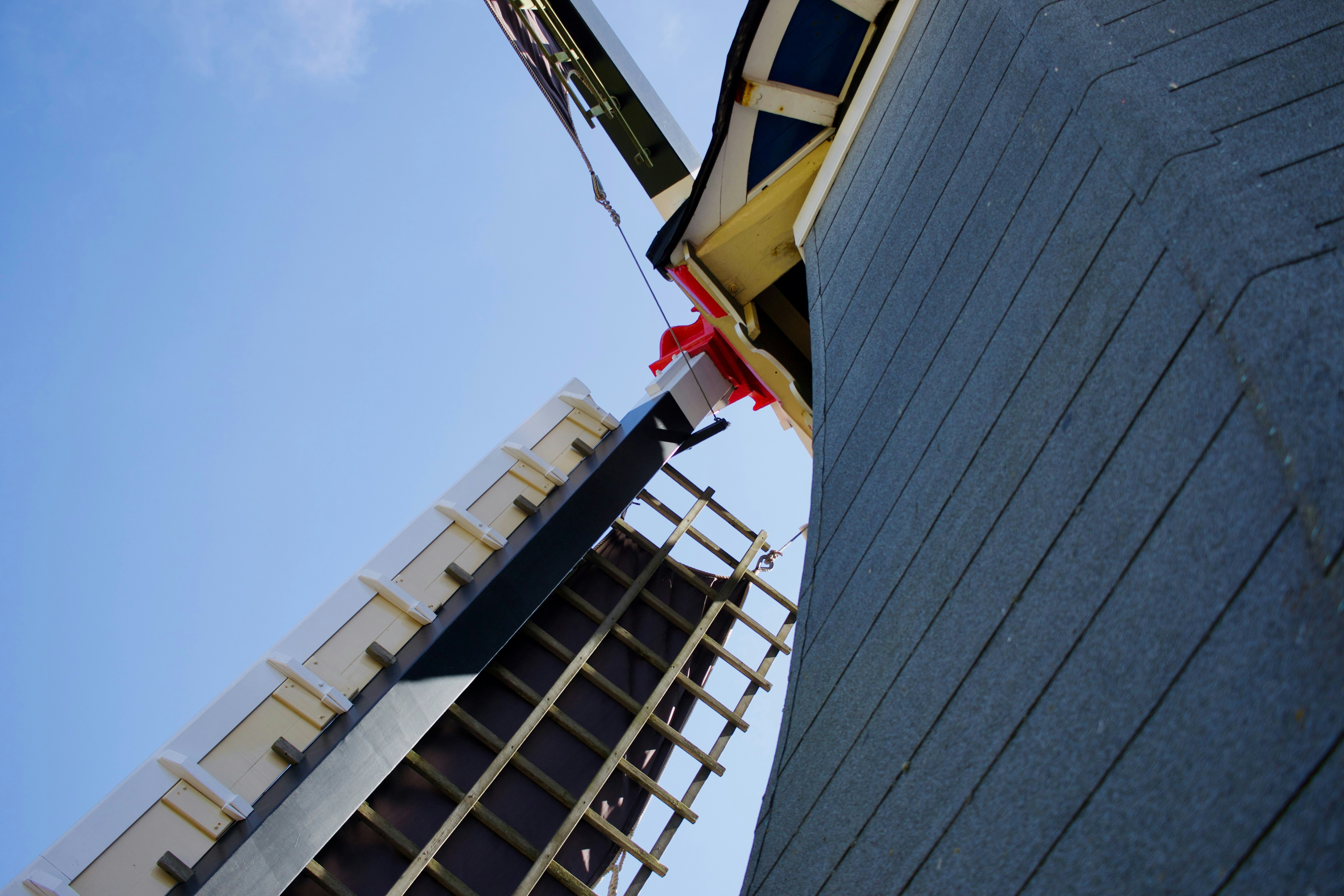 Rising Structure: Red Crane Edge Against a Skyward Scaffold