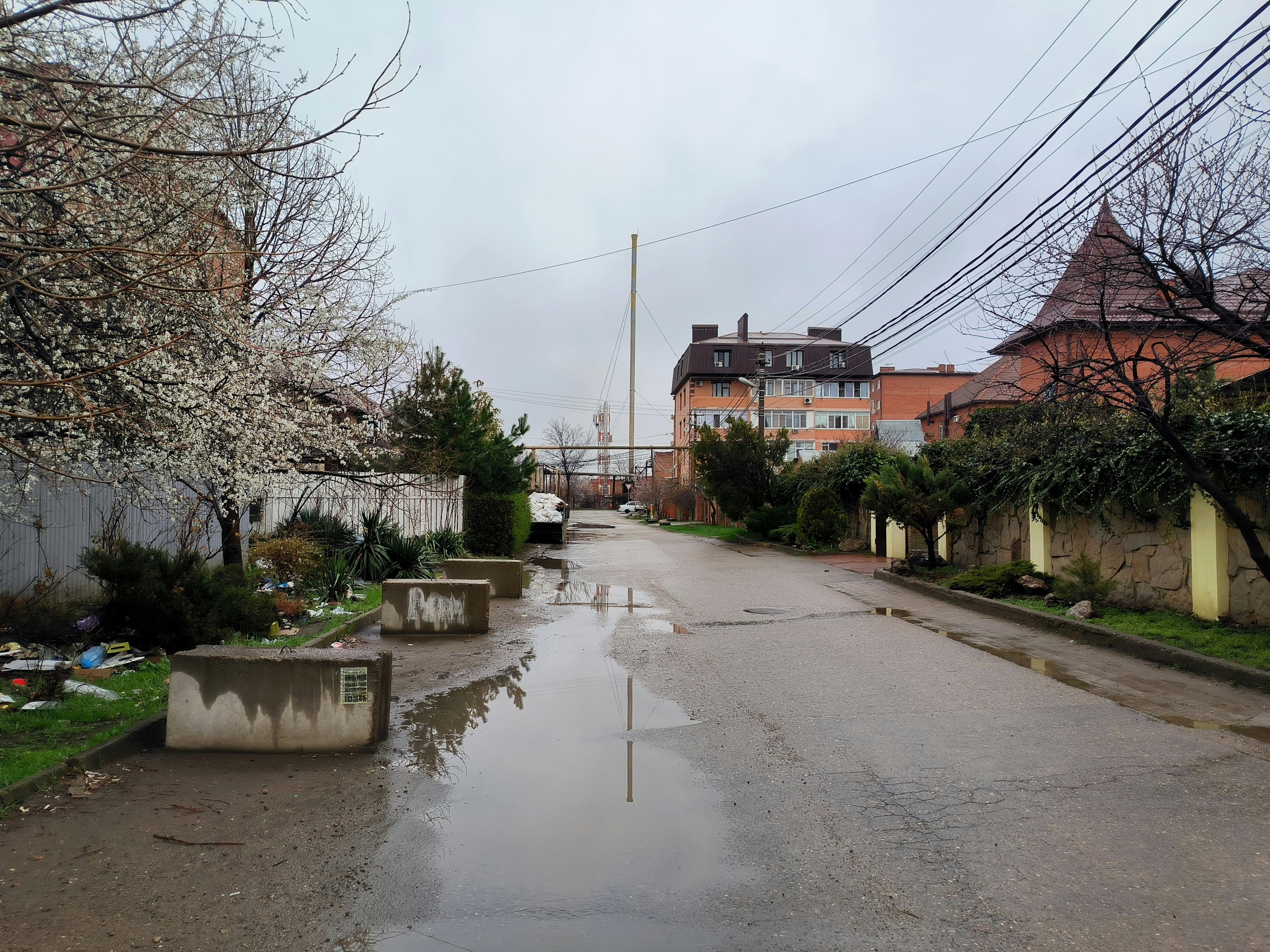 Quiet Rain-Washed Street Toward the Distant Brick Building
