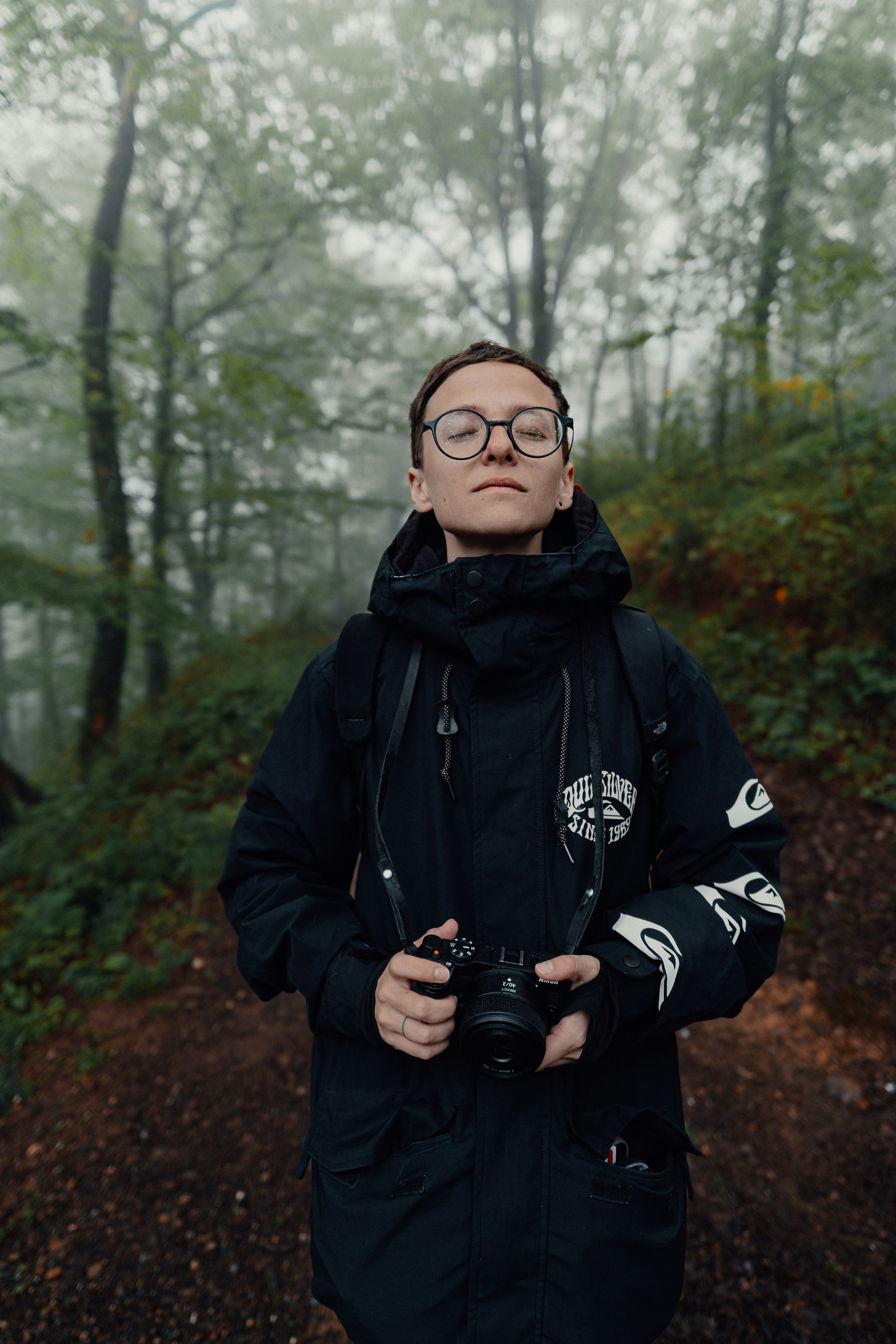 Portrait in the Mist: Youthful Photographer in a Rainy Forest