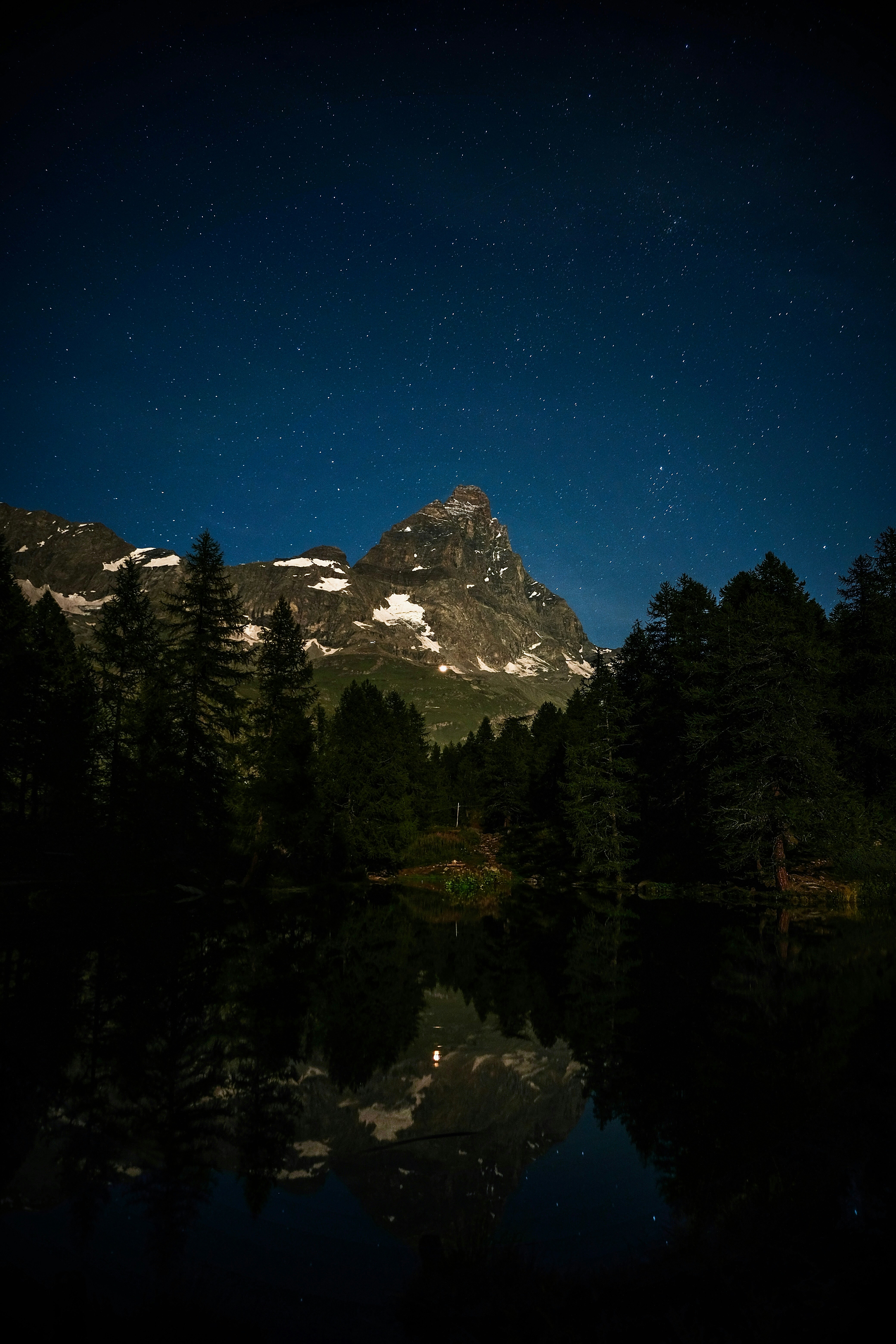 Moonlit Peak and Silent Lake Under a Starry Veil