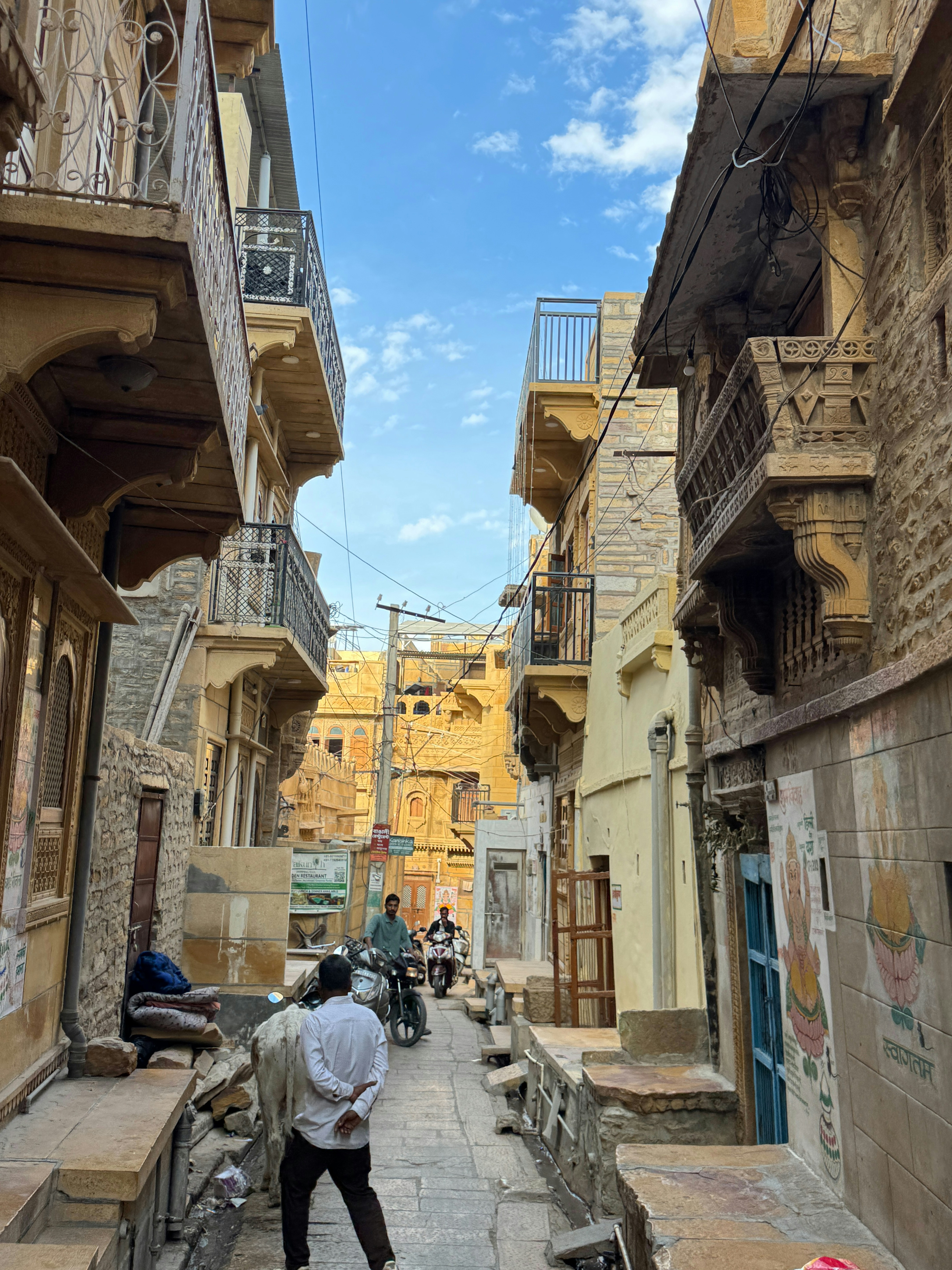 Sunlit Street Corridor of Balconied Stone—A Quiet City Moment