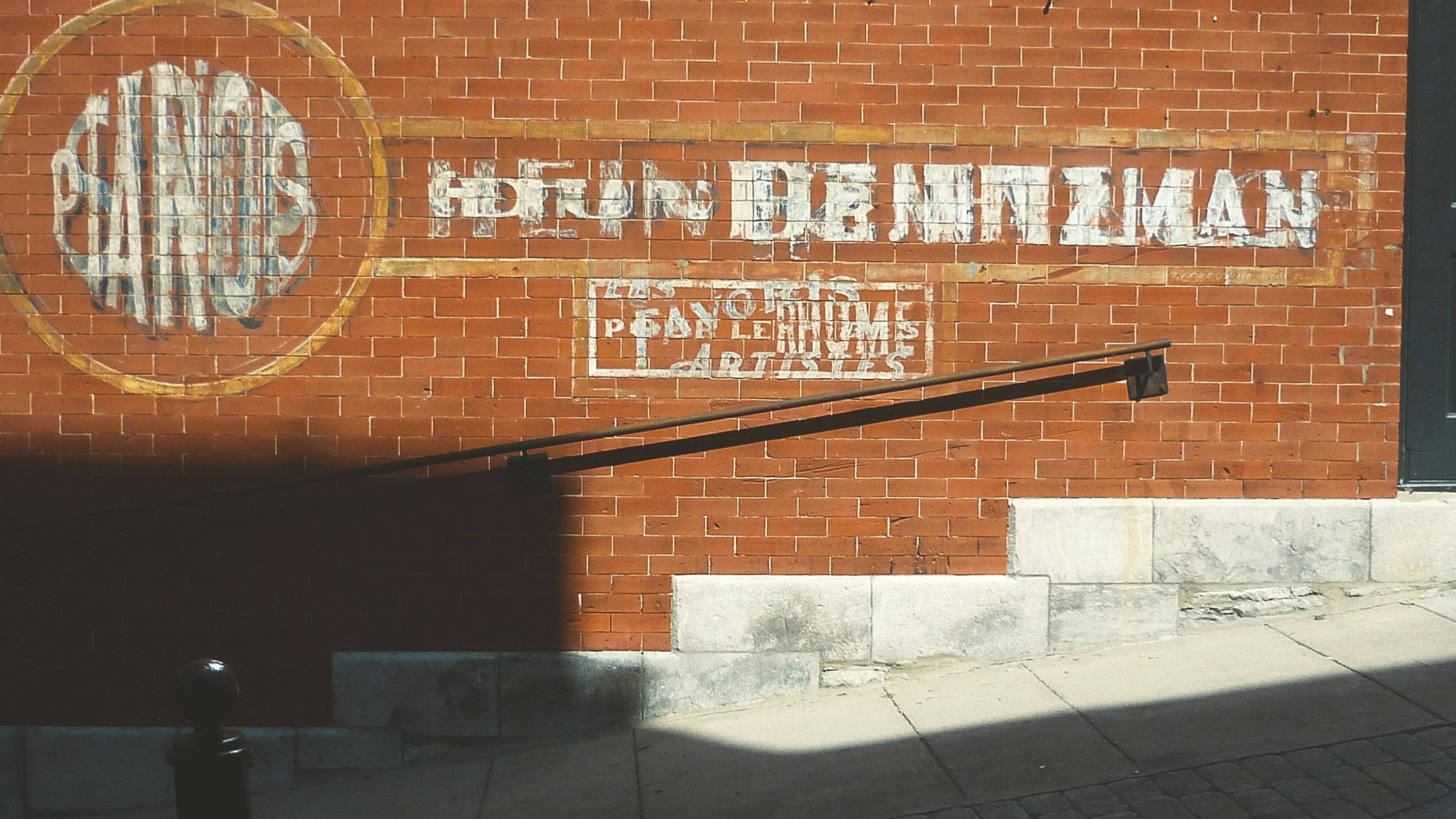 Brick Wall Ghost Sign: Fading Pennsylvanian Art in a Shaded Alley