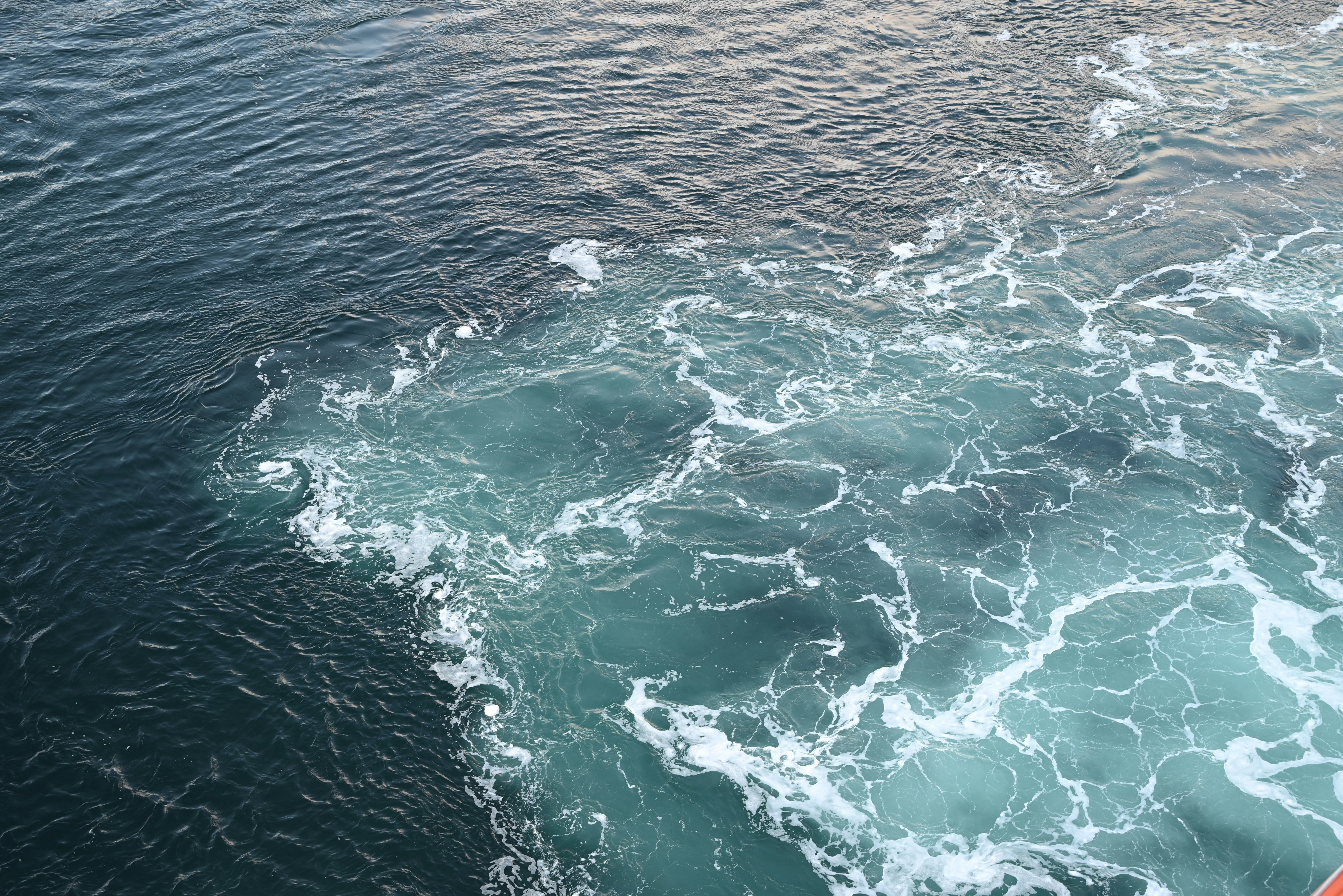 Edge of Turquoise Whirl: A Break of Ocean in Motion