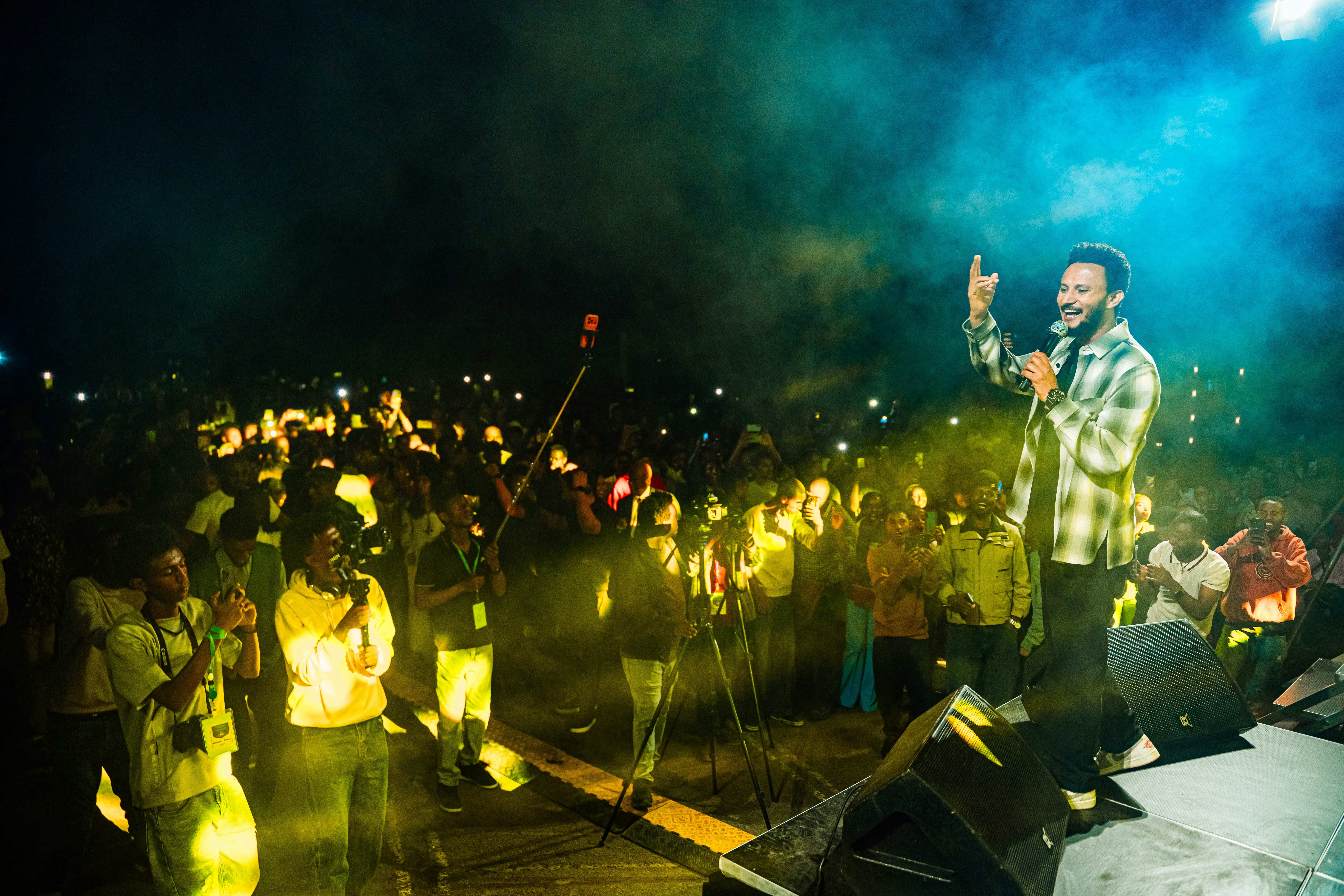 Onstage Radiance: The Lead Performer Amid a Sea of Echoing Lights