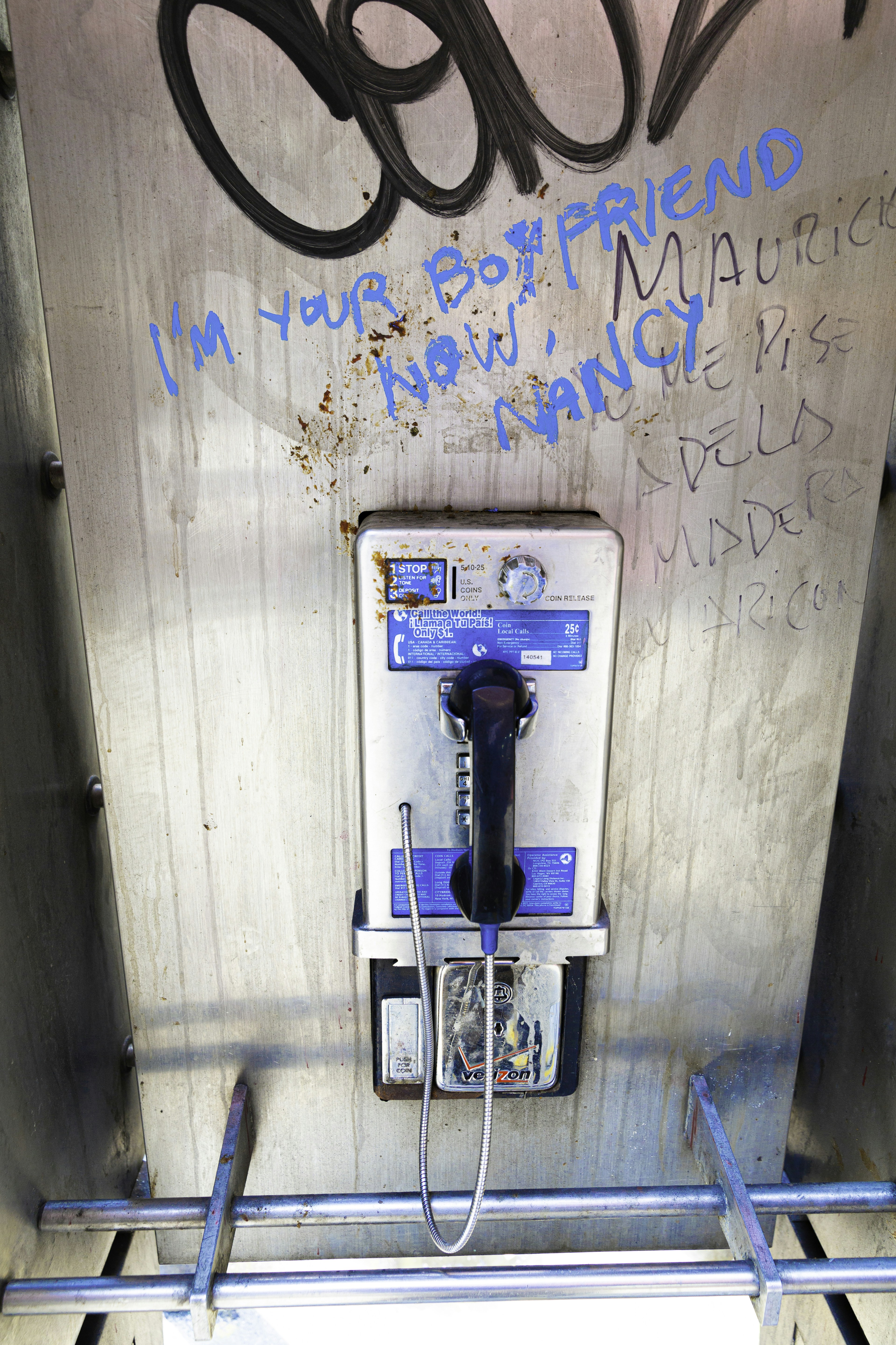 Blue Graffiti on a Payphone: Urban Decay in Metal