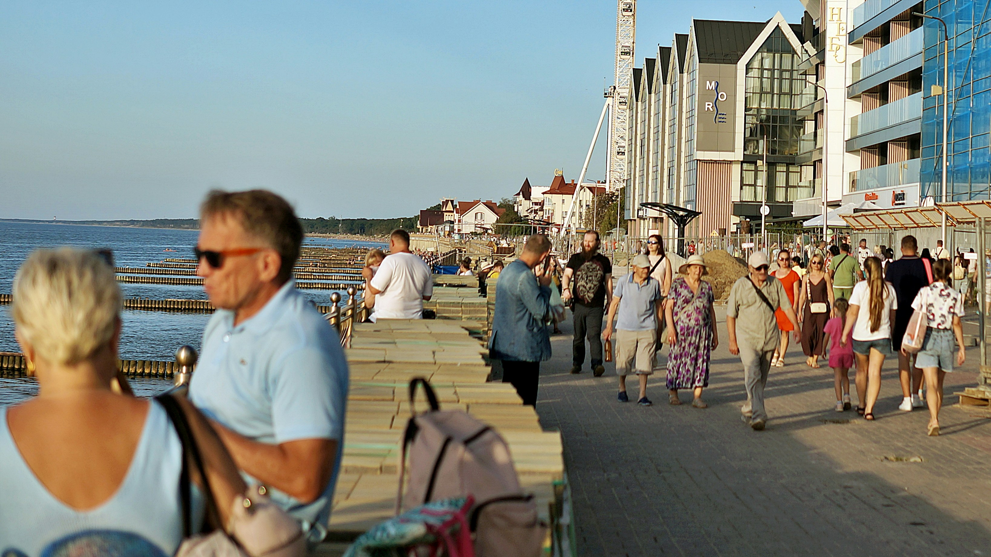 Boardwalk Buzz: Sunlit Day Along a Coastal Promenade