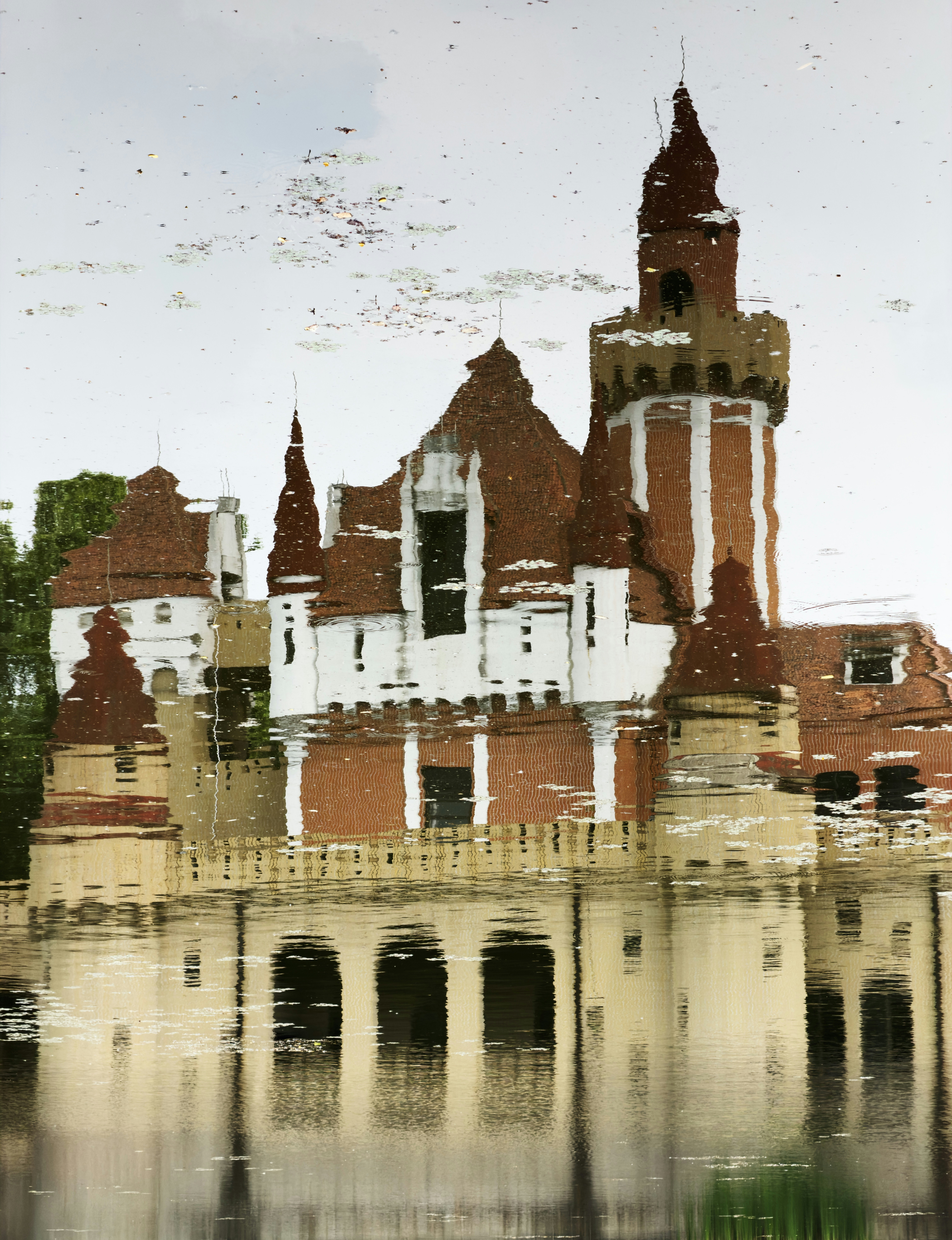 Red-roofed skyline reflected in calm waters