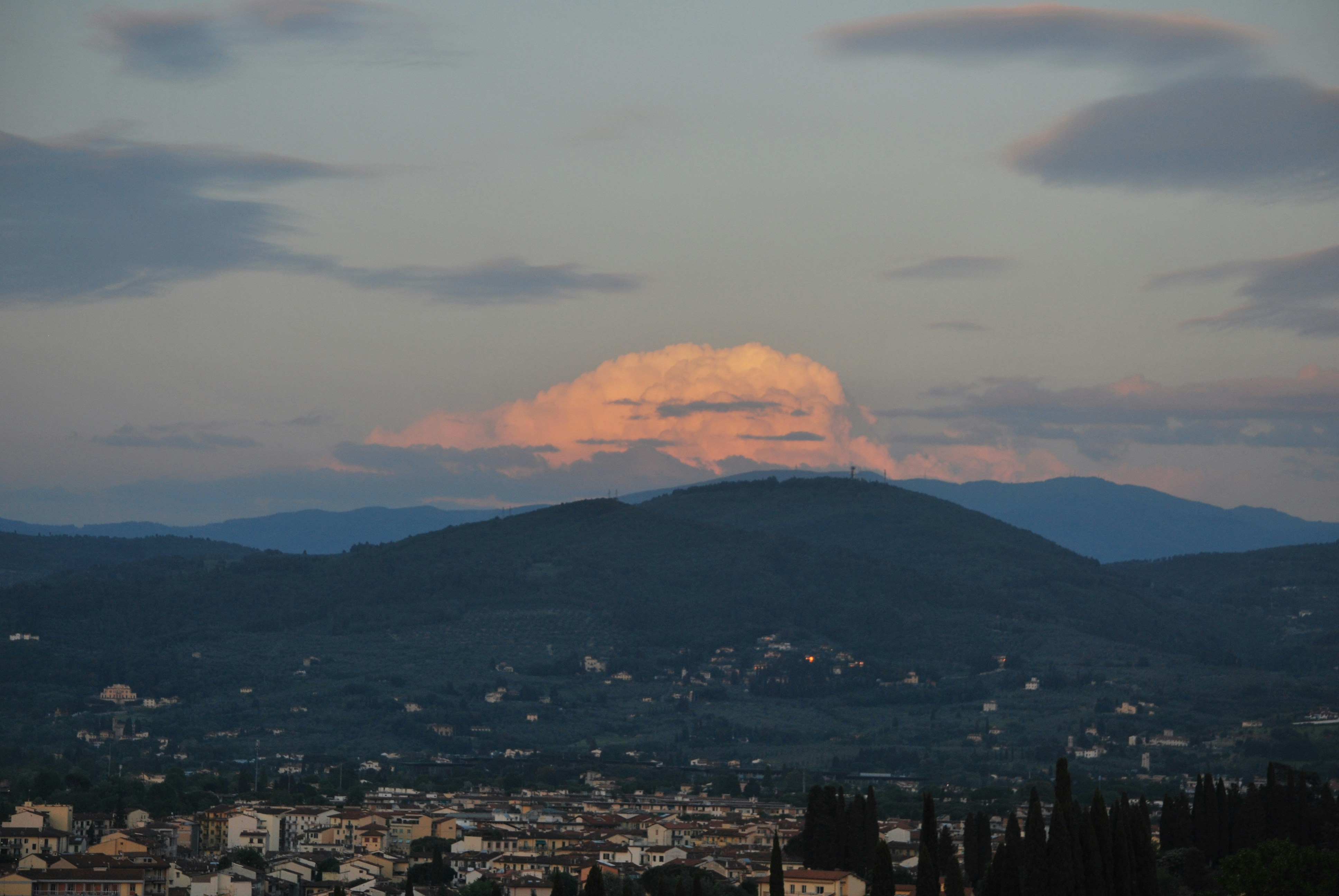 Dawn Cloud Over the Hills: A Quiet Cityscape Under a Colored Sky
