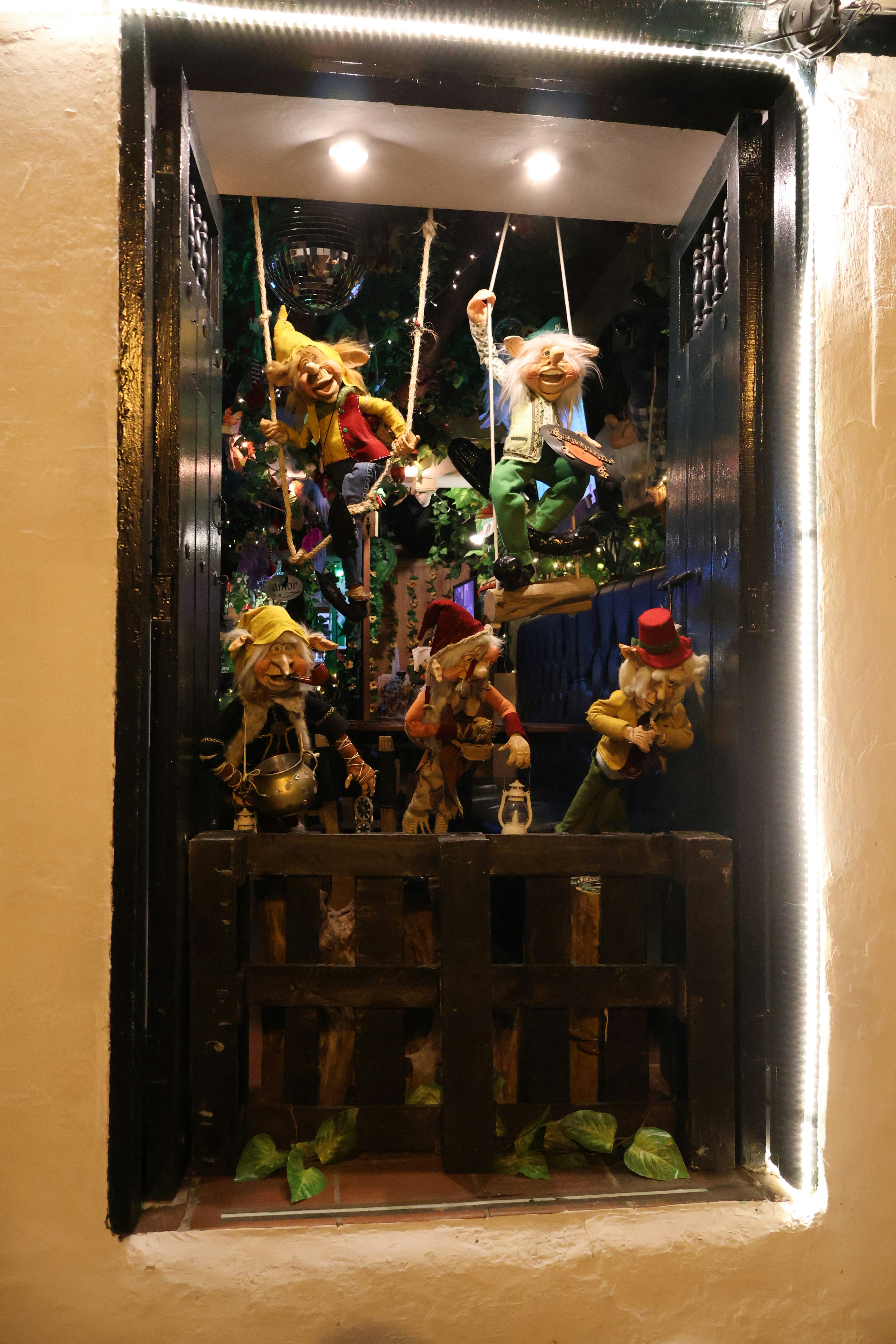 Clockwork Harvest: Puppets Swinging Above a Rustic Stage