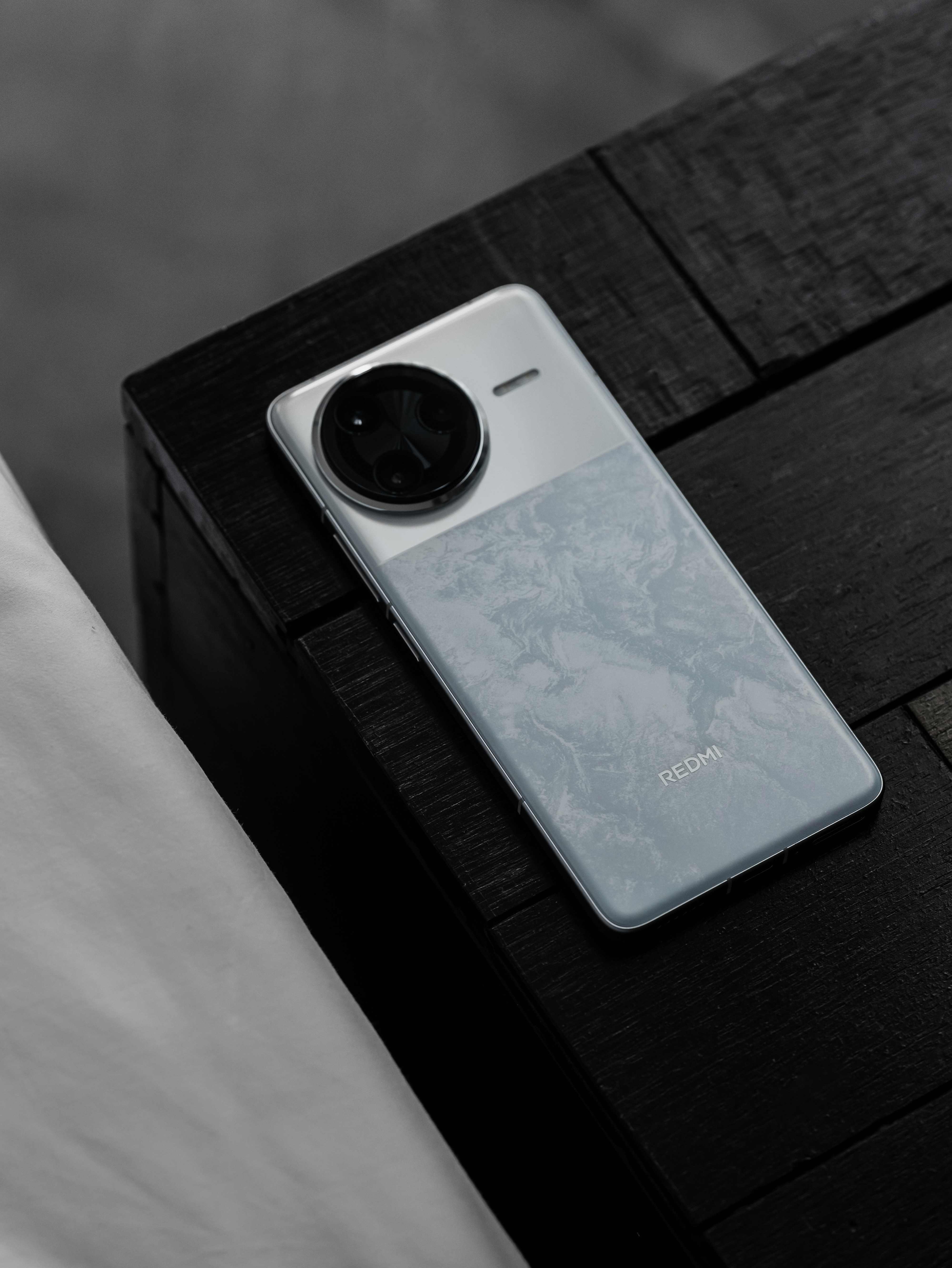Midnight Reflection: A Xiaomi Redmi phone resting on a dark wooden surface