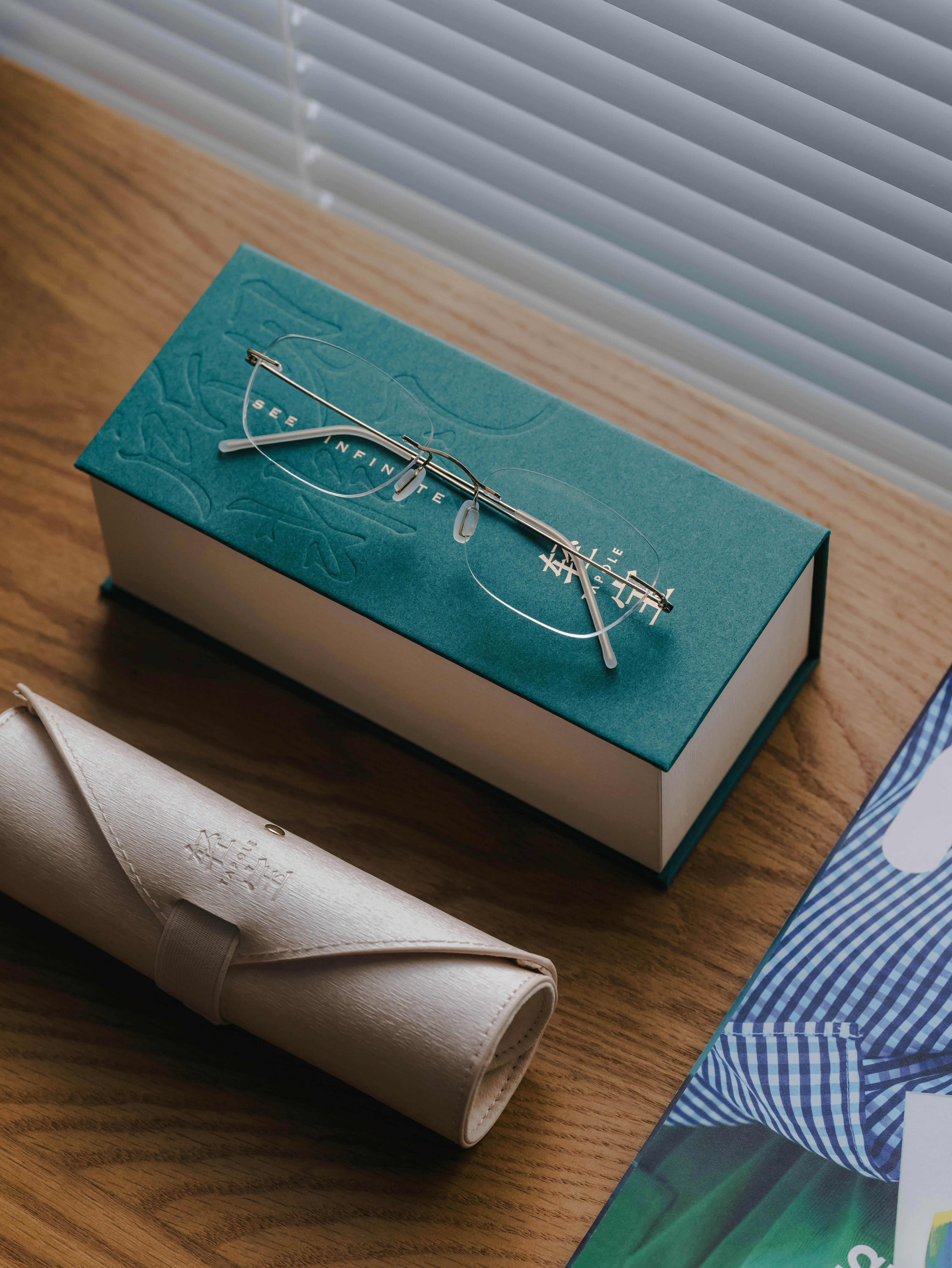 Teal Box of Glasses on a Wooden Desk