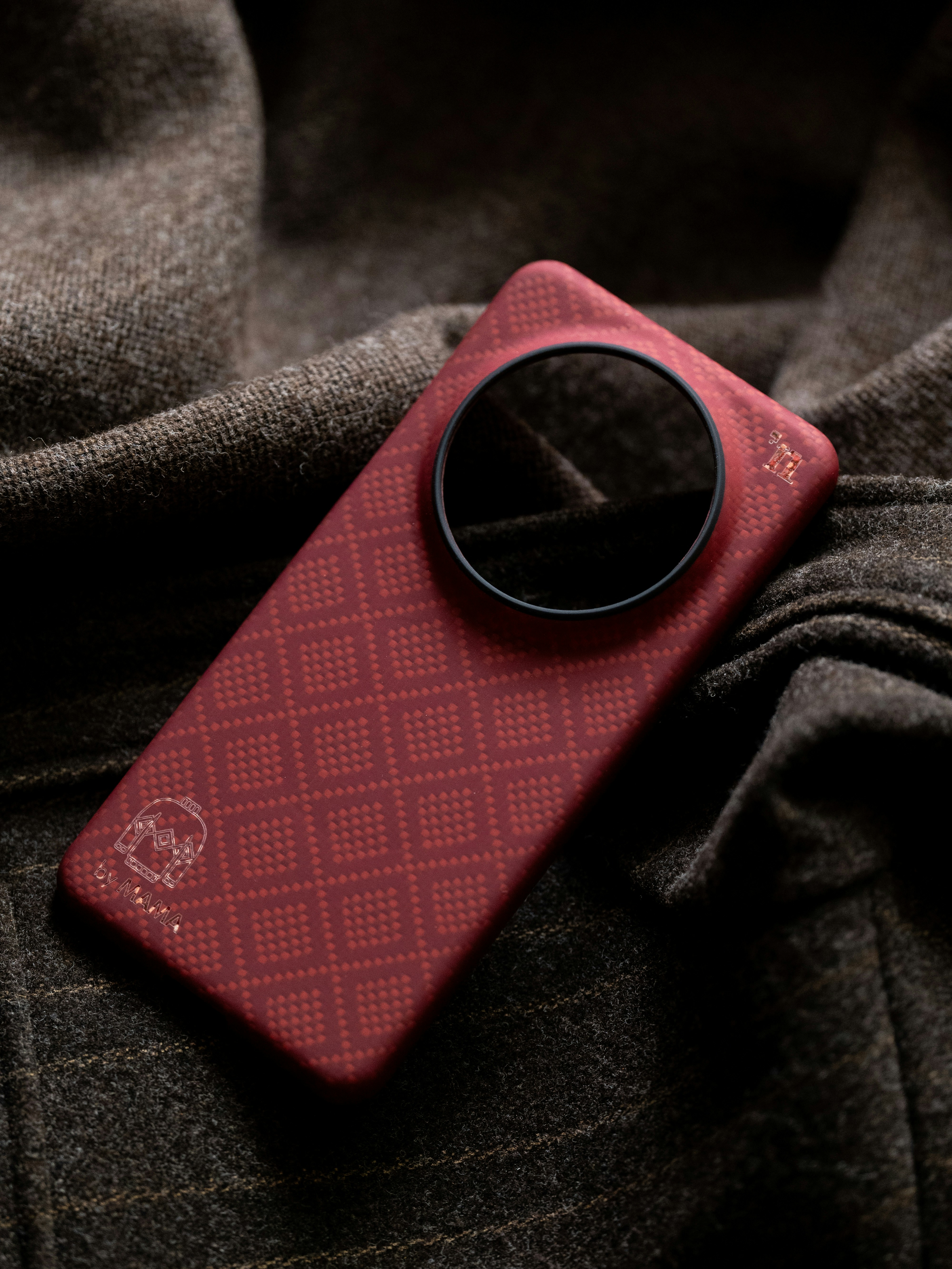 Red Minimalist: a geometric pocket lens resting on velvet
