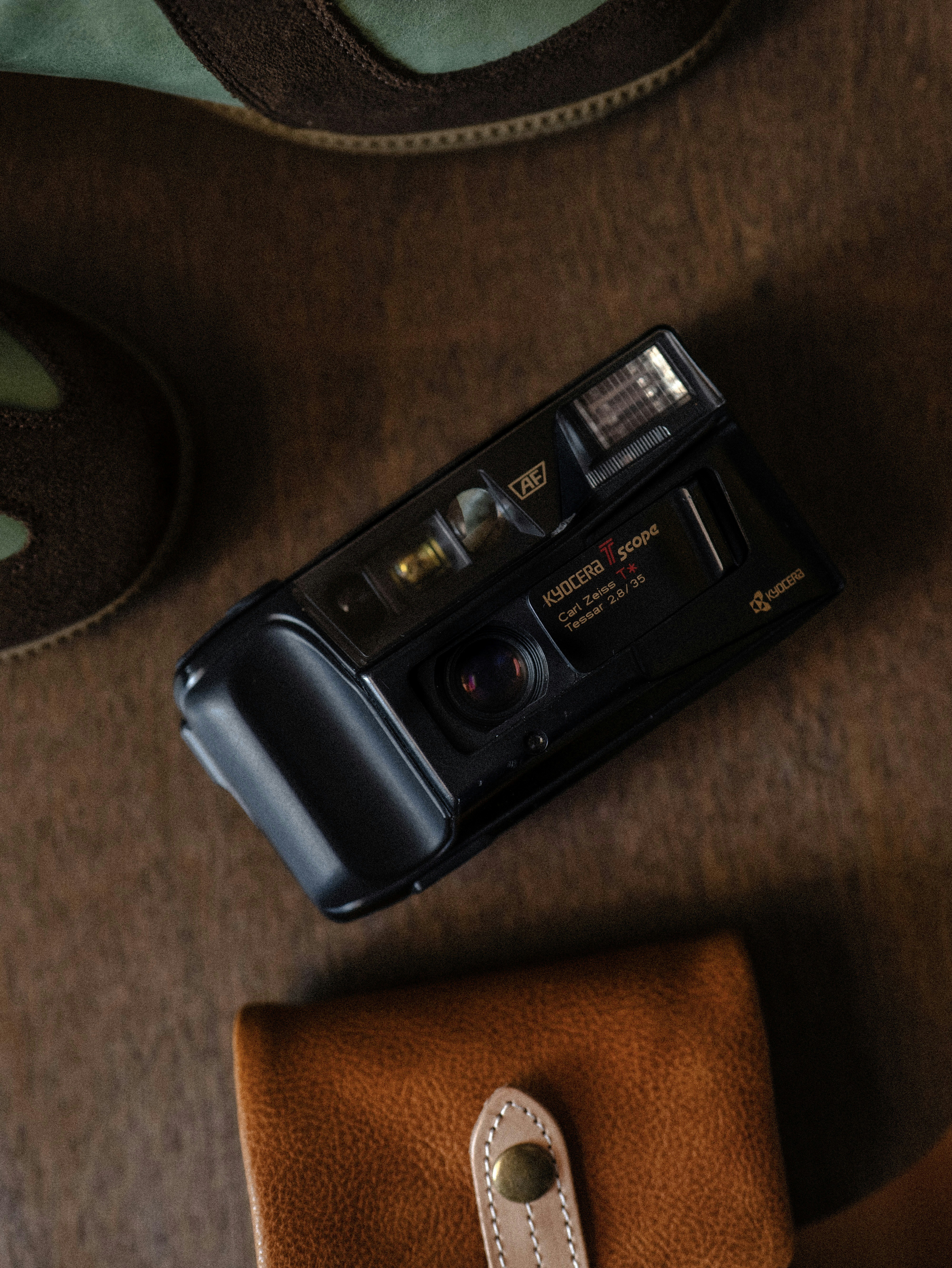 Vintage Compact: A Classic Film Camera Resting Beside a Leather Wallet