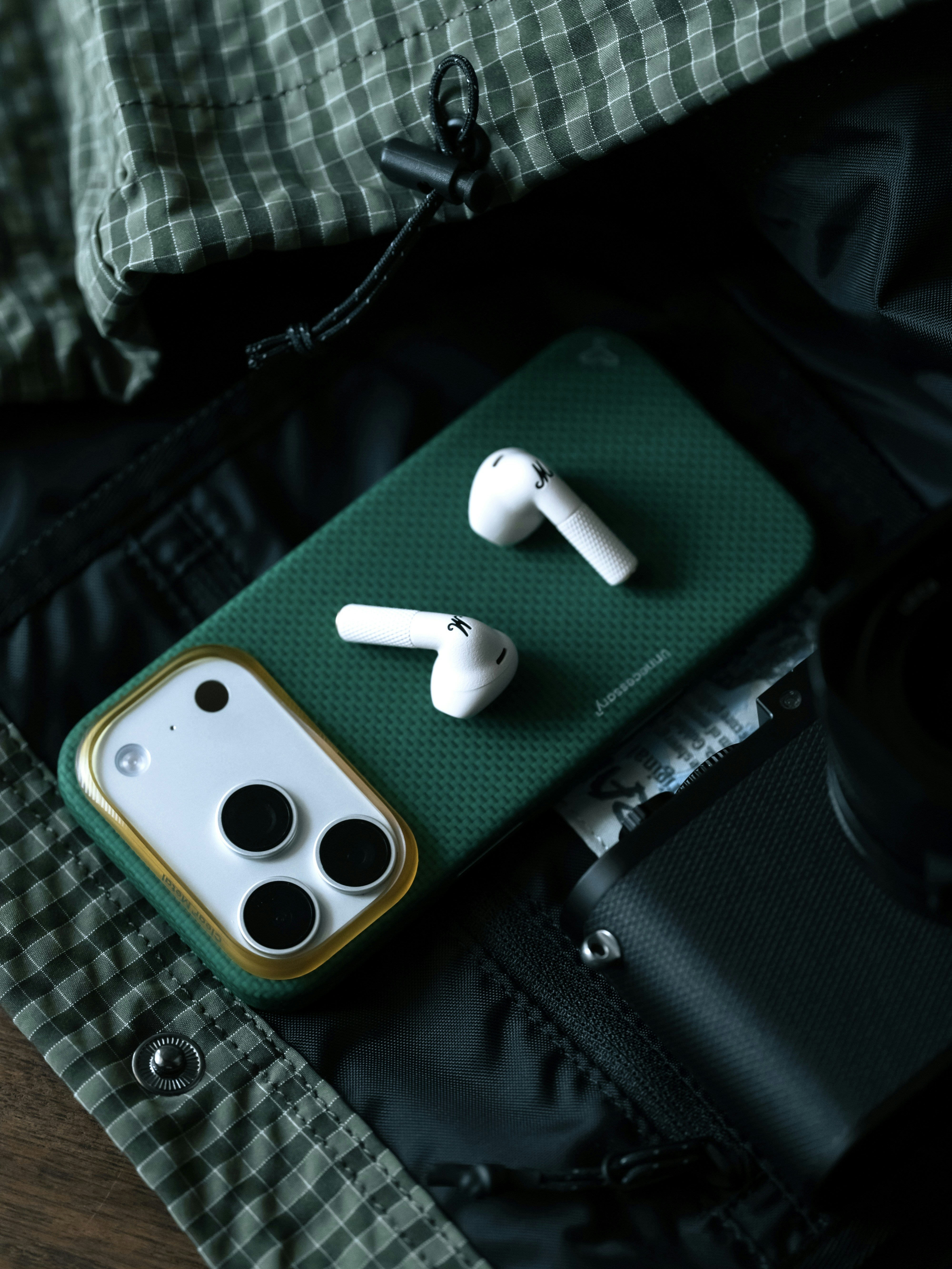 Earbuds in a Green Padded Pocket: A Tech Essentials Moment