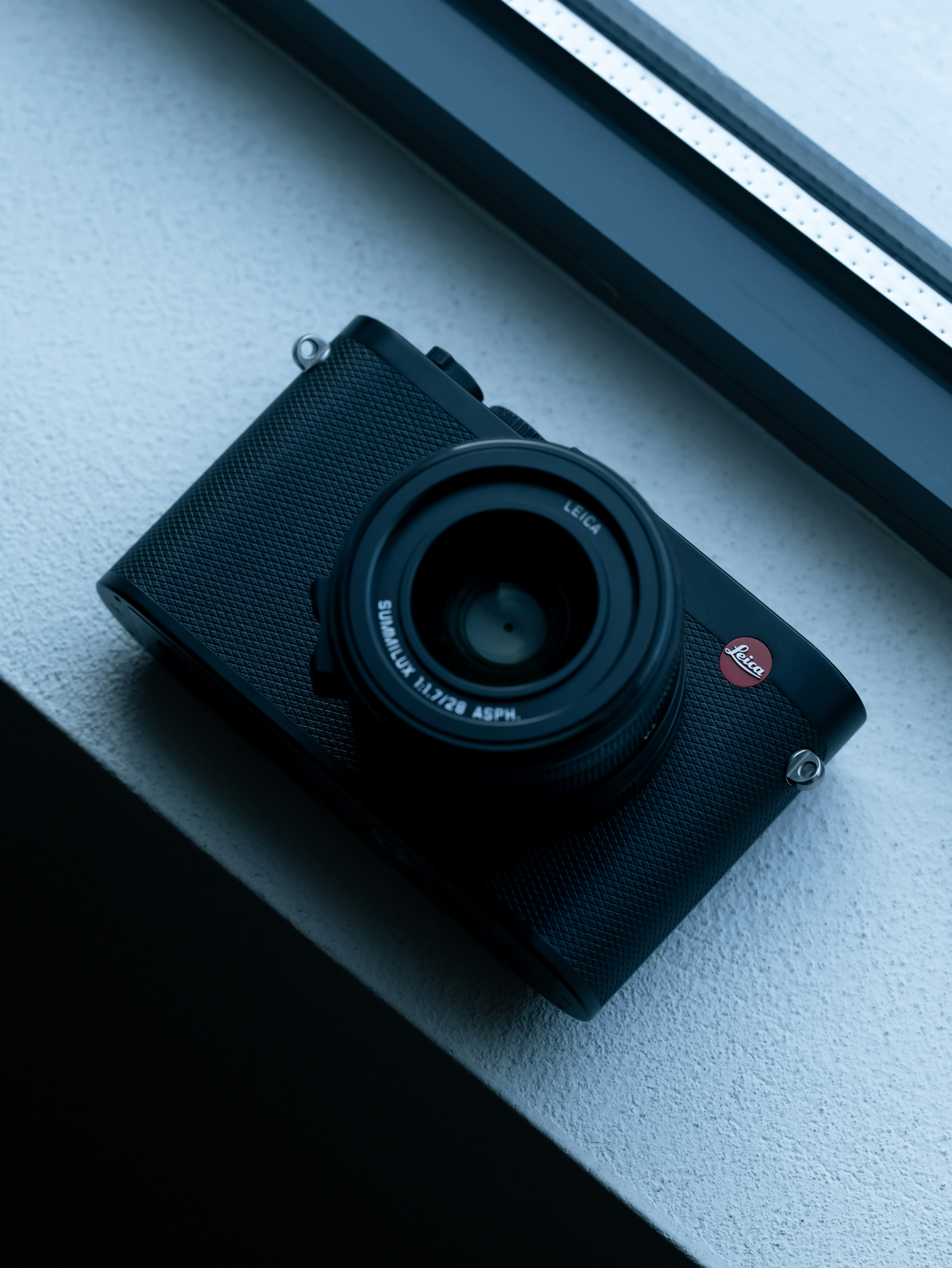 Leica on a Tilt: A Quiet Studio Camera Resting by the Window