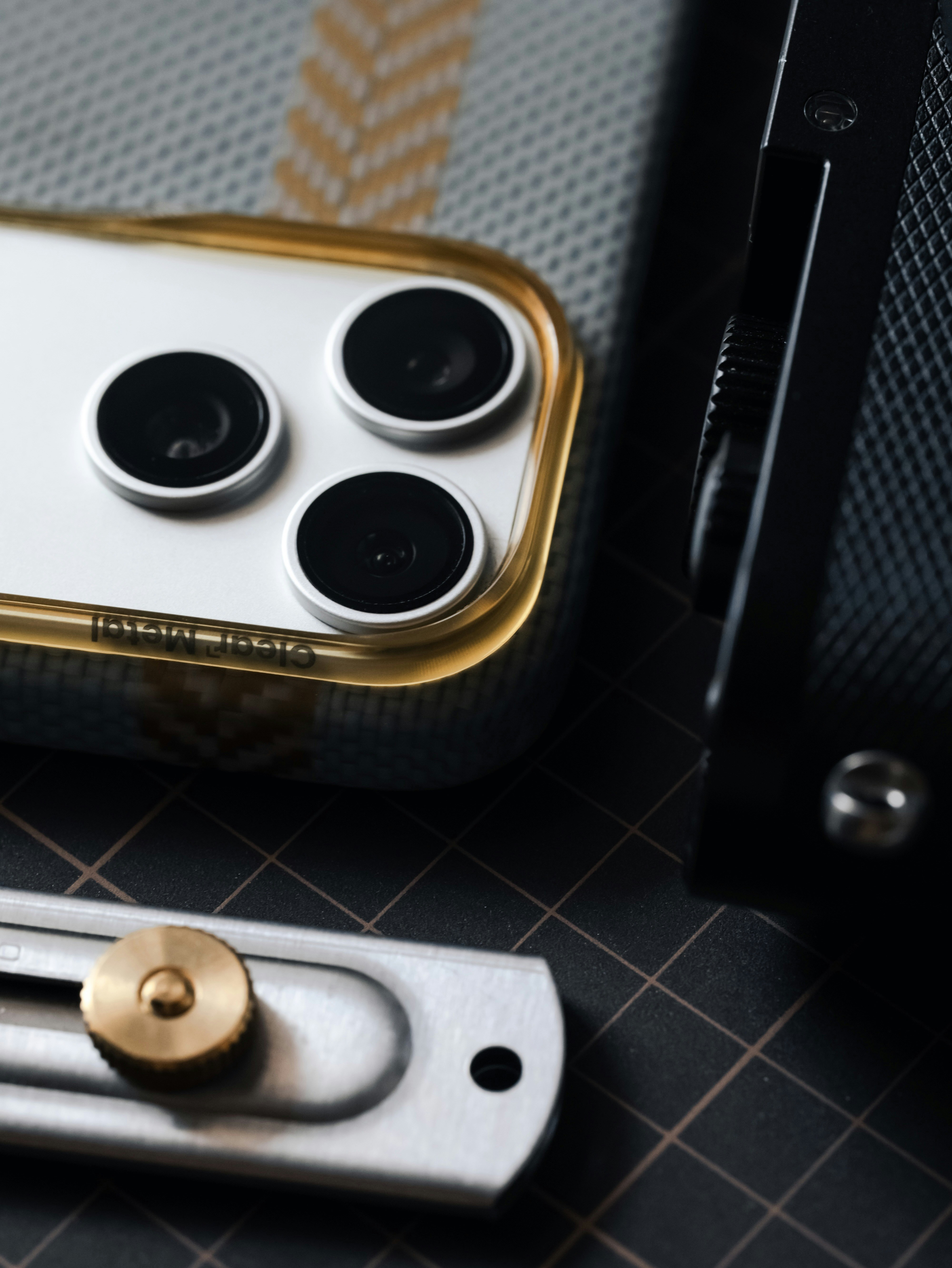Close-up of a Smartphone Camera Module and Vintage-Style Accessories