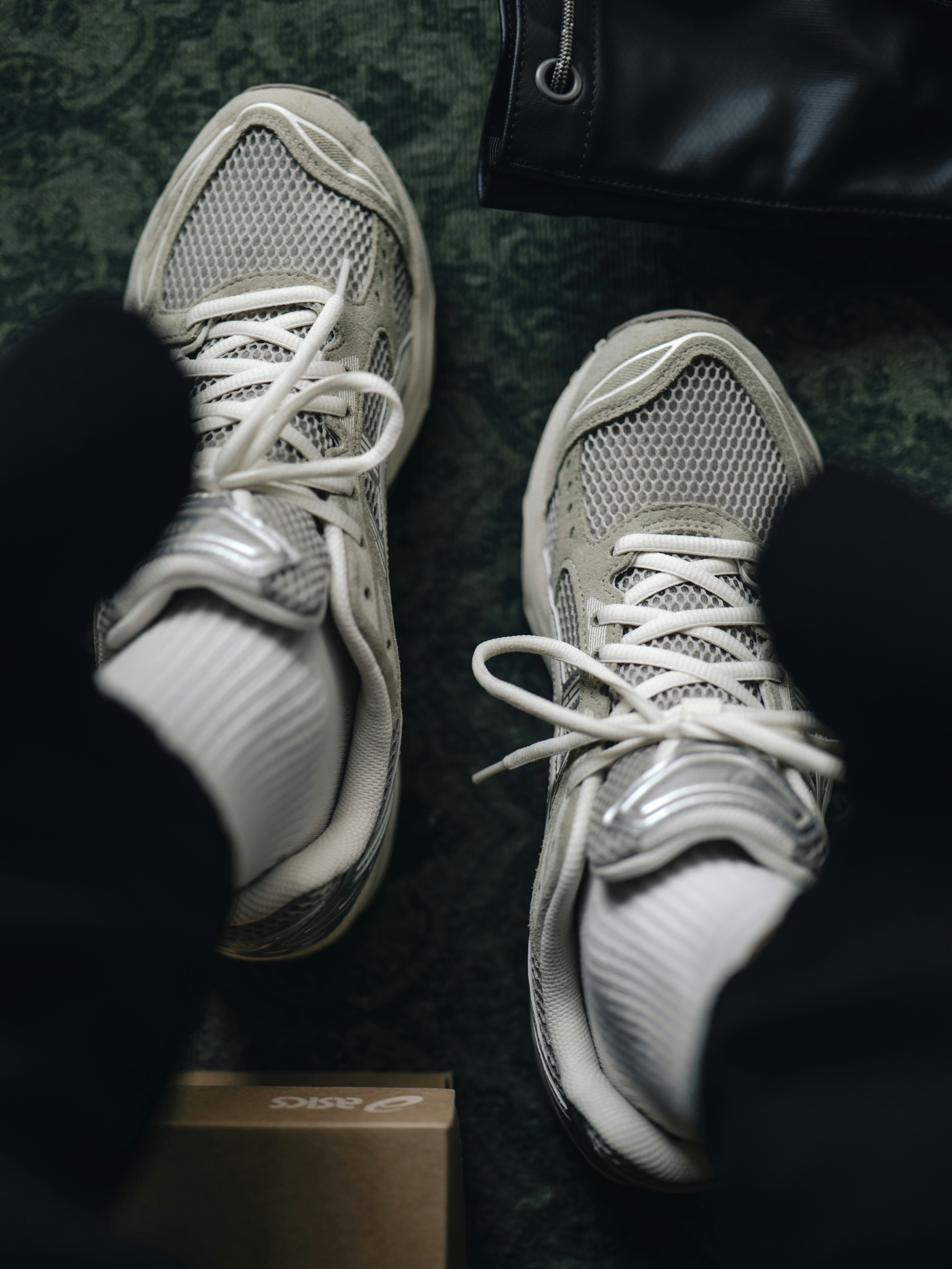 Person wearing light athletic shoes and white socks.