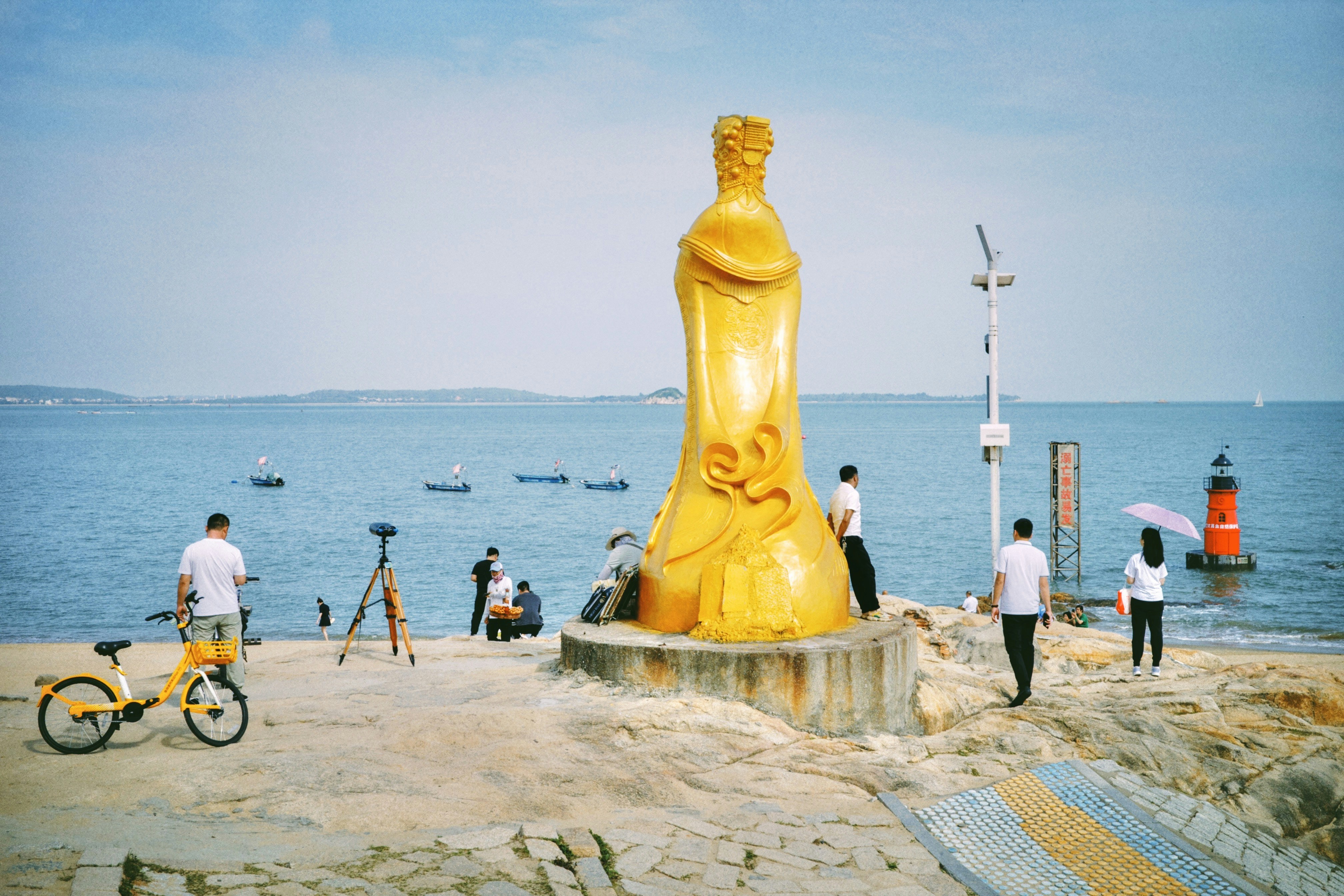 Golden Seated Statue by the Sea