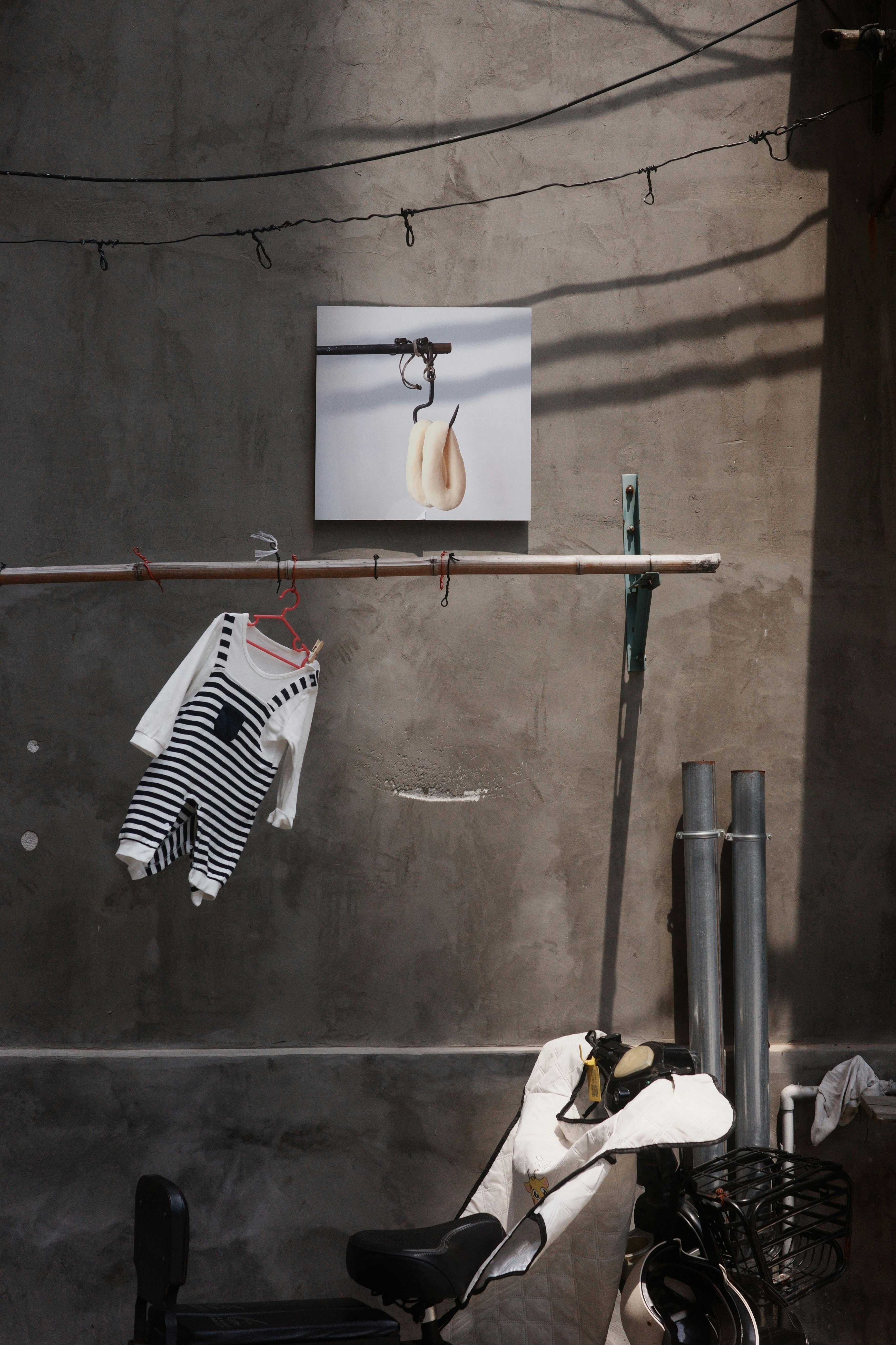Hanging Wardrobe: A Sparse Still-Life on a Weathered Wall