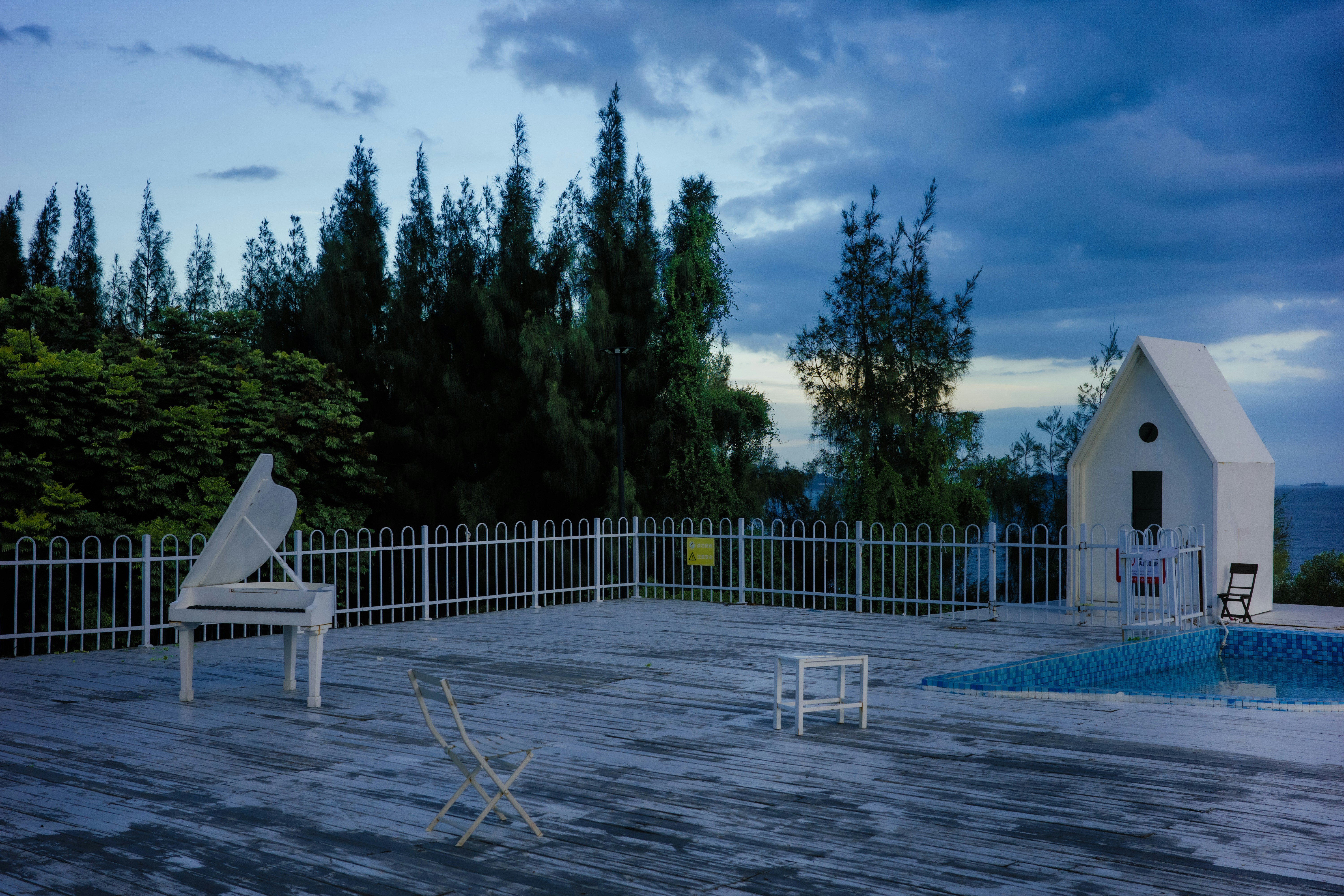 Muted Blue Terrace: A Quiet Poolside Scene at Dusk