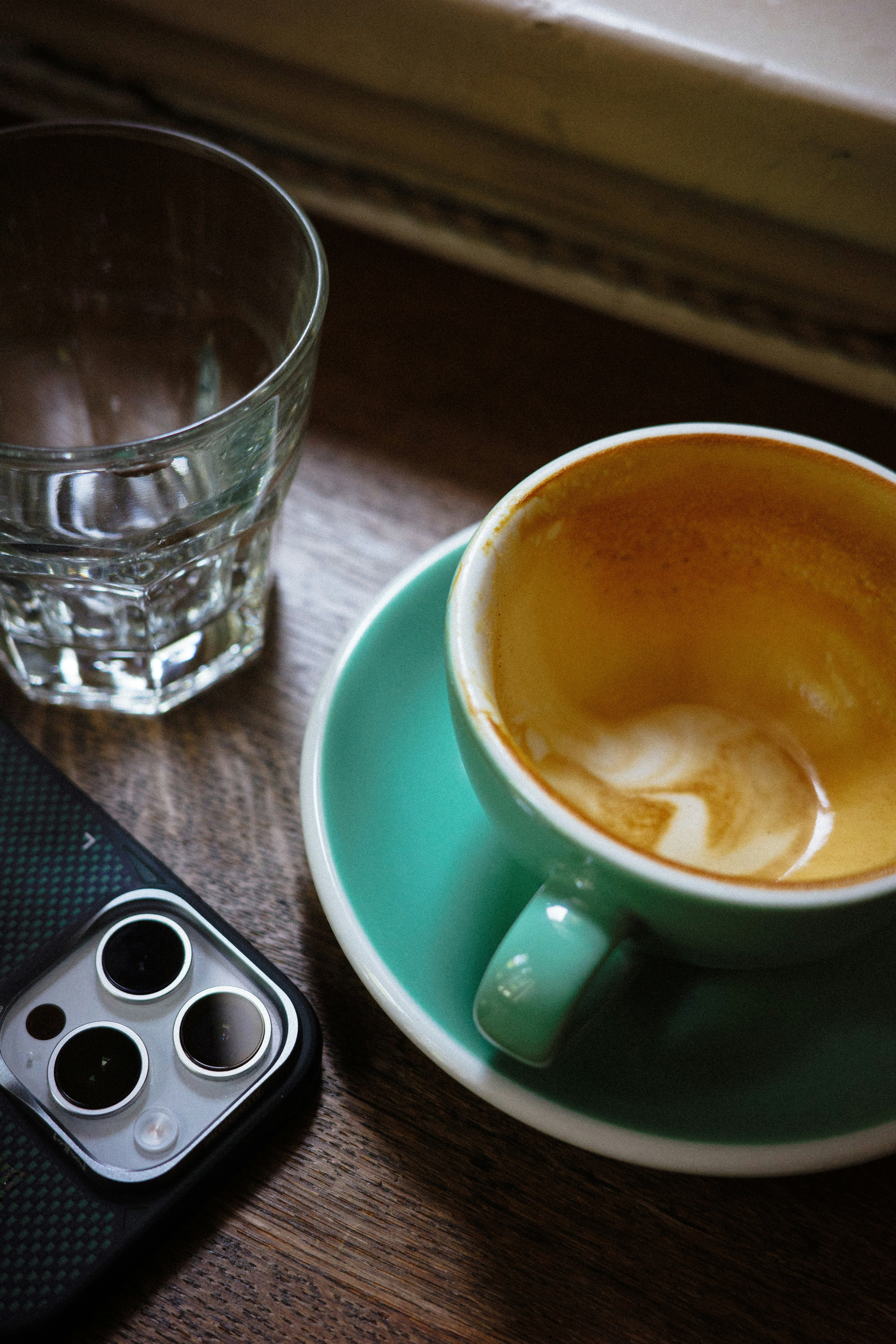 Espresso cup with a phone and glass