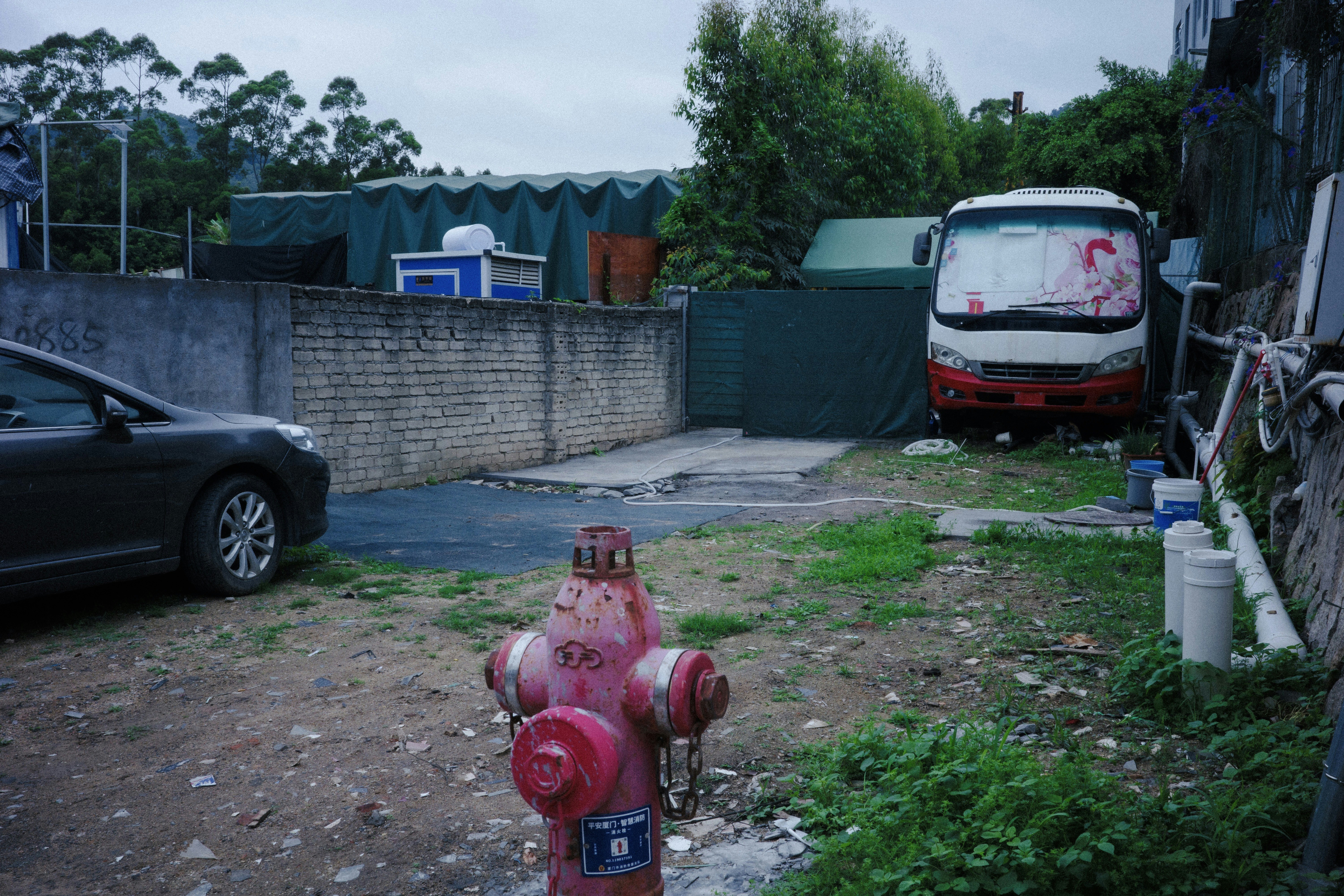Red Fire Hydrant in an Urban Lot: A Quiet Backstreet Scene