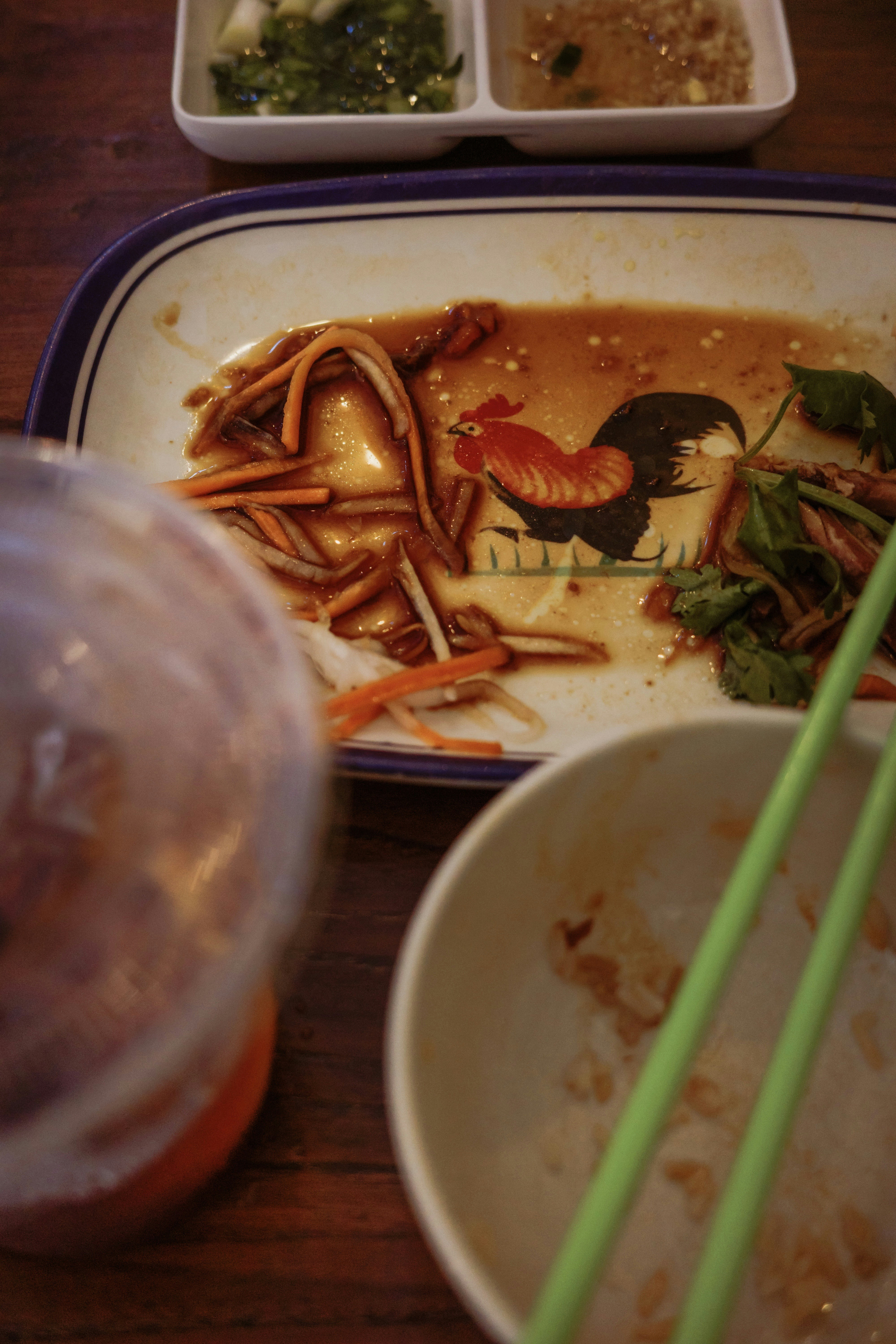 Dirty plate with leftover food and chopsticks