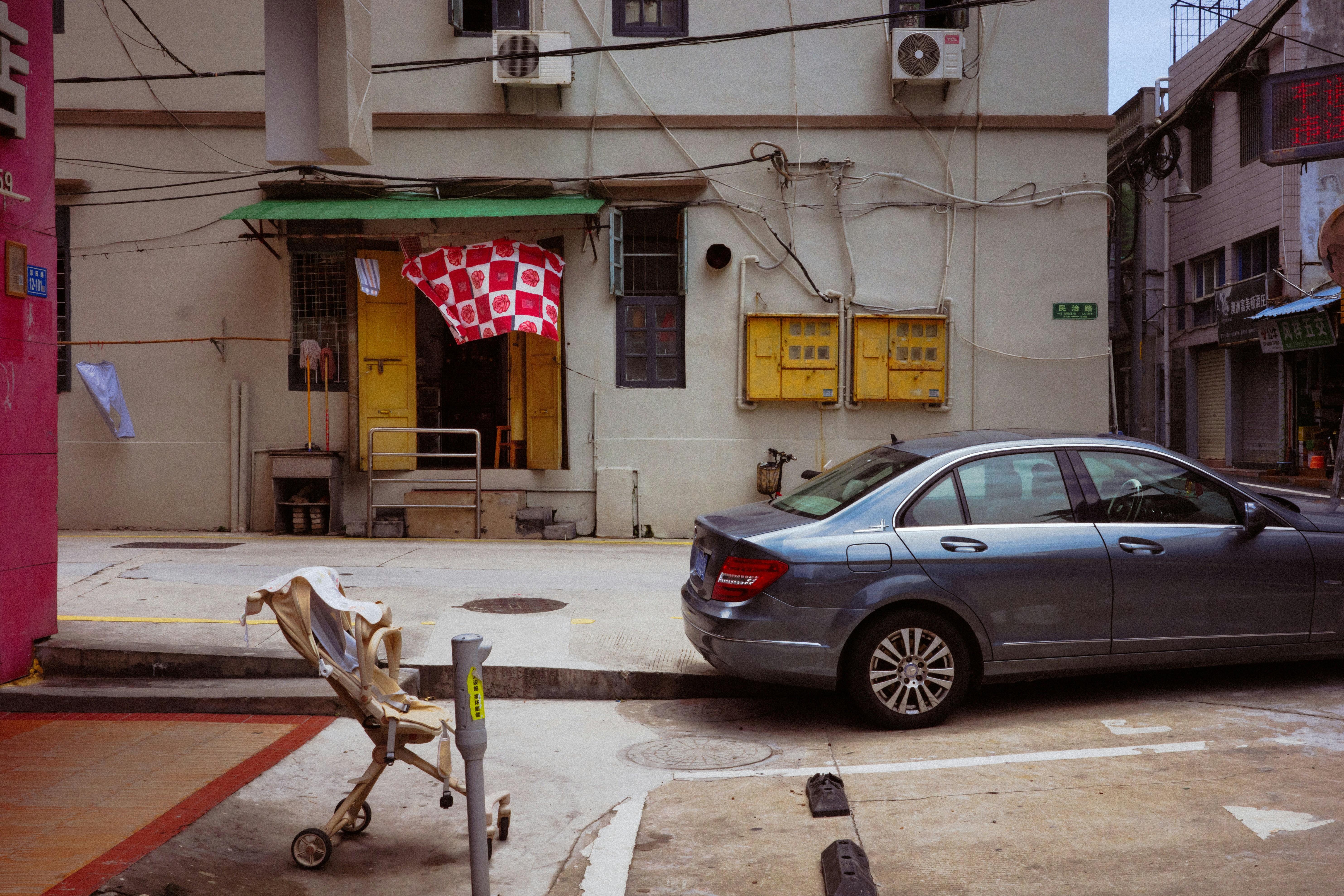 Streetfront Still Life with Aged Facade and Parked Car