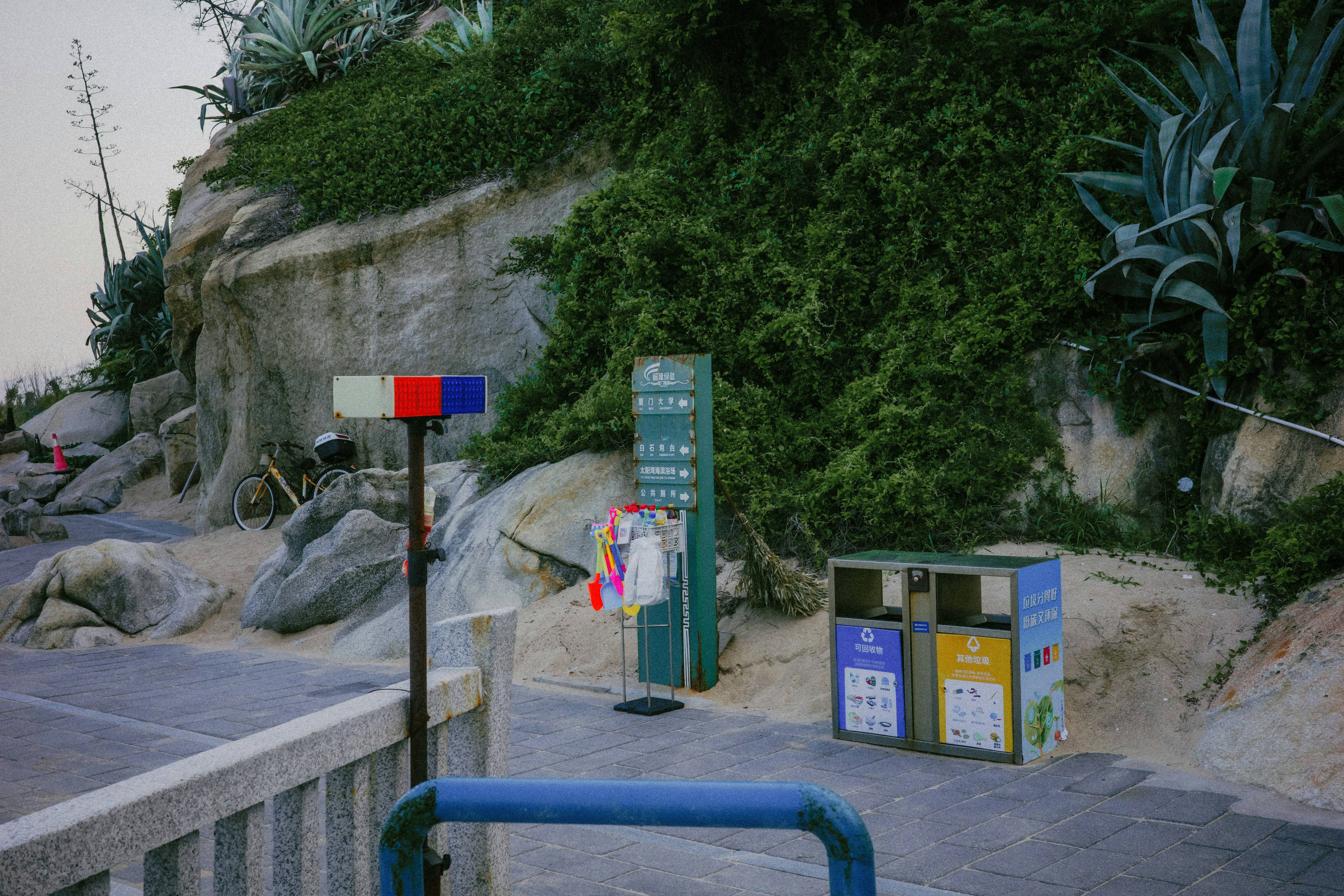 Coastal Steps and Urban Trash Receptacles at a Cliffside Pathway