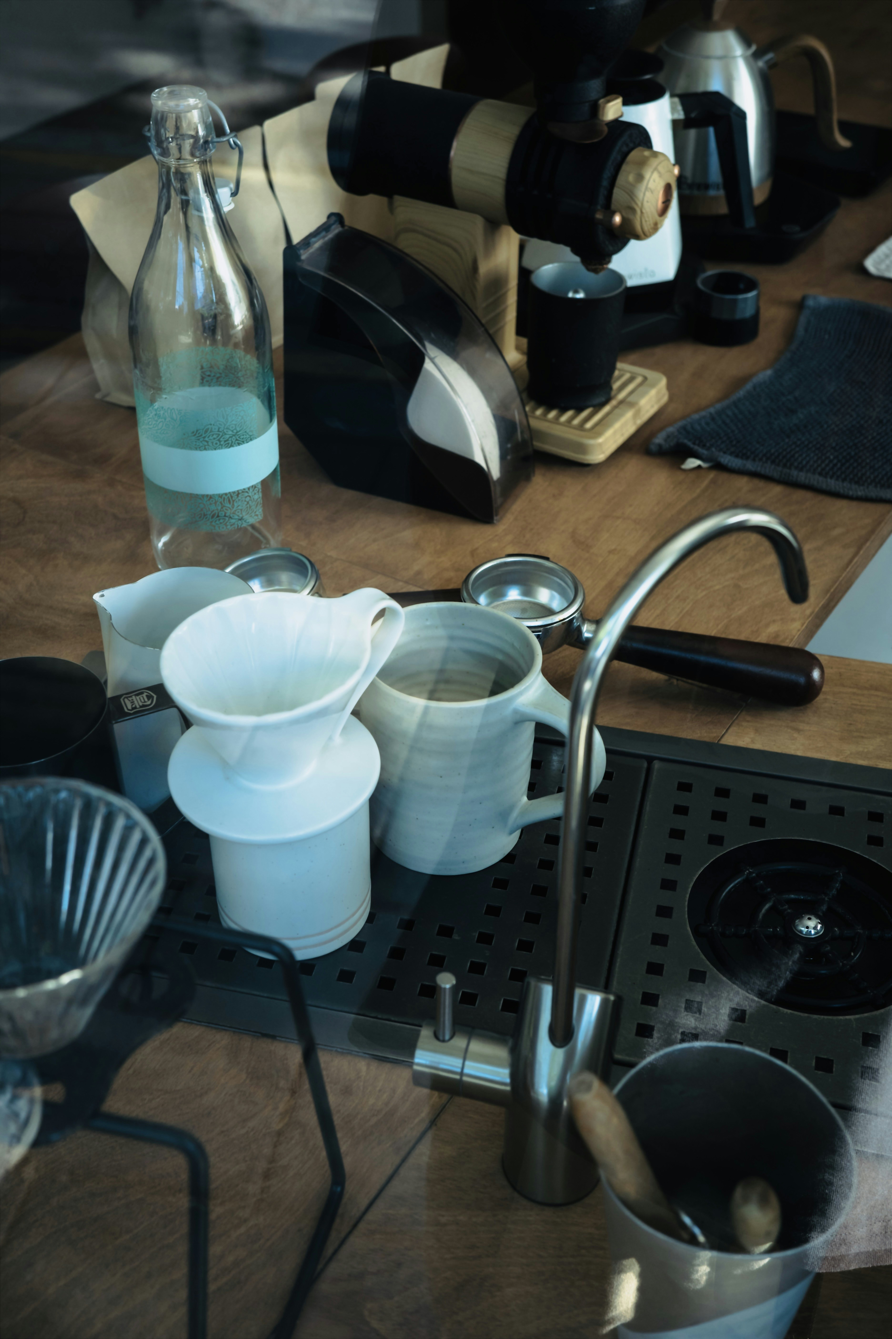 Coffee brewing equipment arranged on a wooden counter.