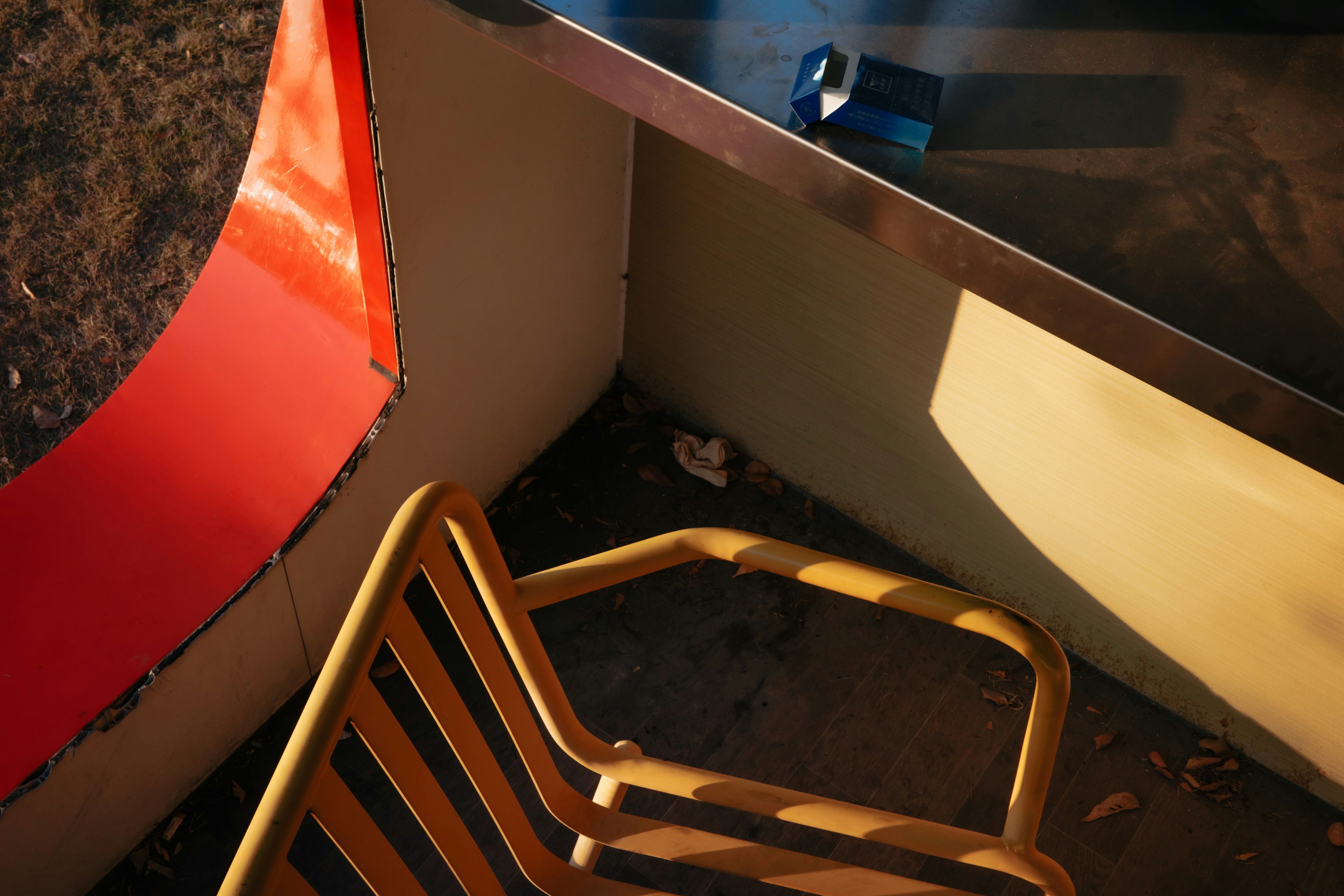 Sunlit Terrace Grains: A Concrete Corner and a Yellow Handrail
