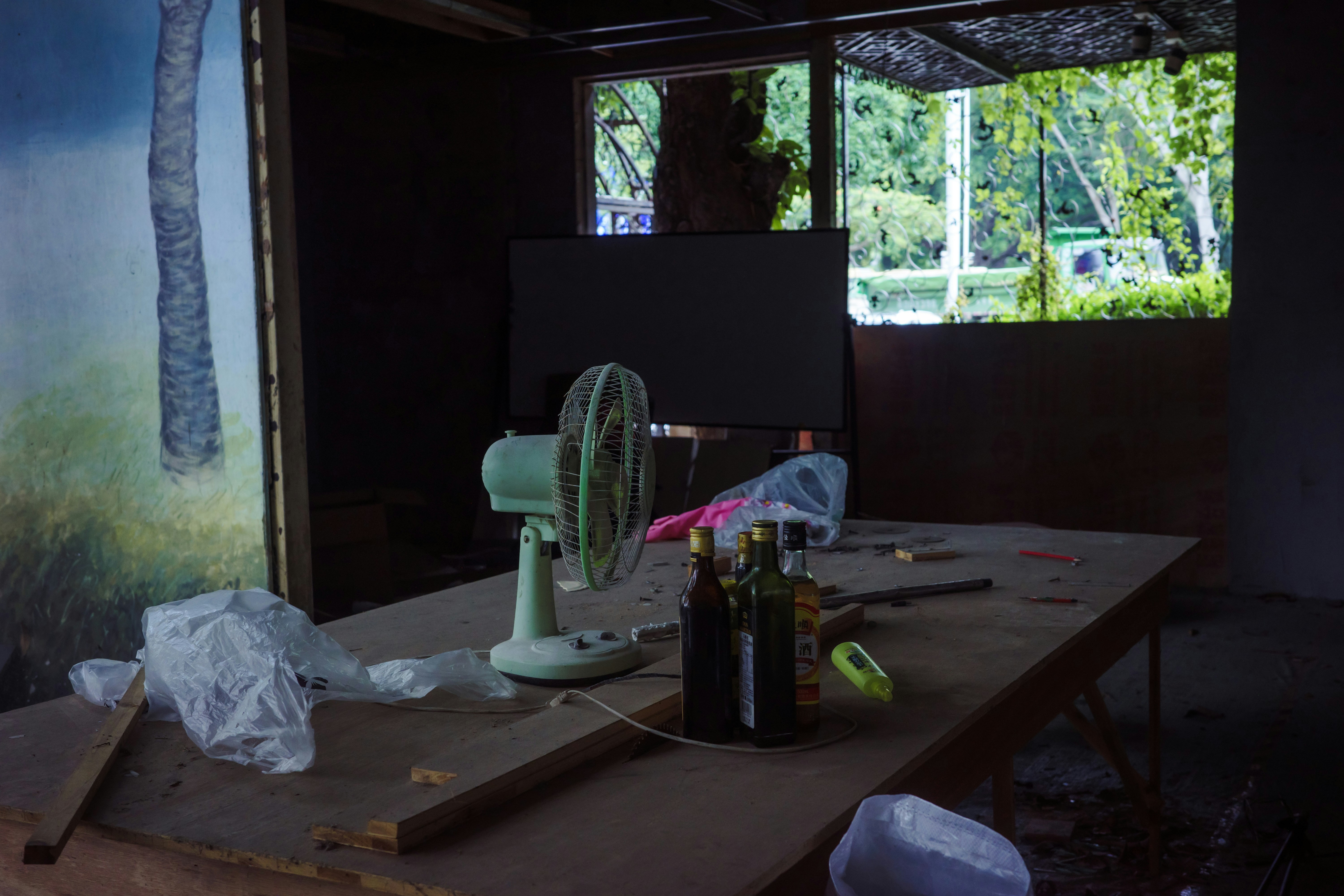 Dusty Workbench Sanctuary: A Quiet Moment with a Small Fan